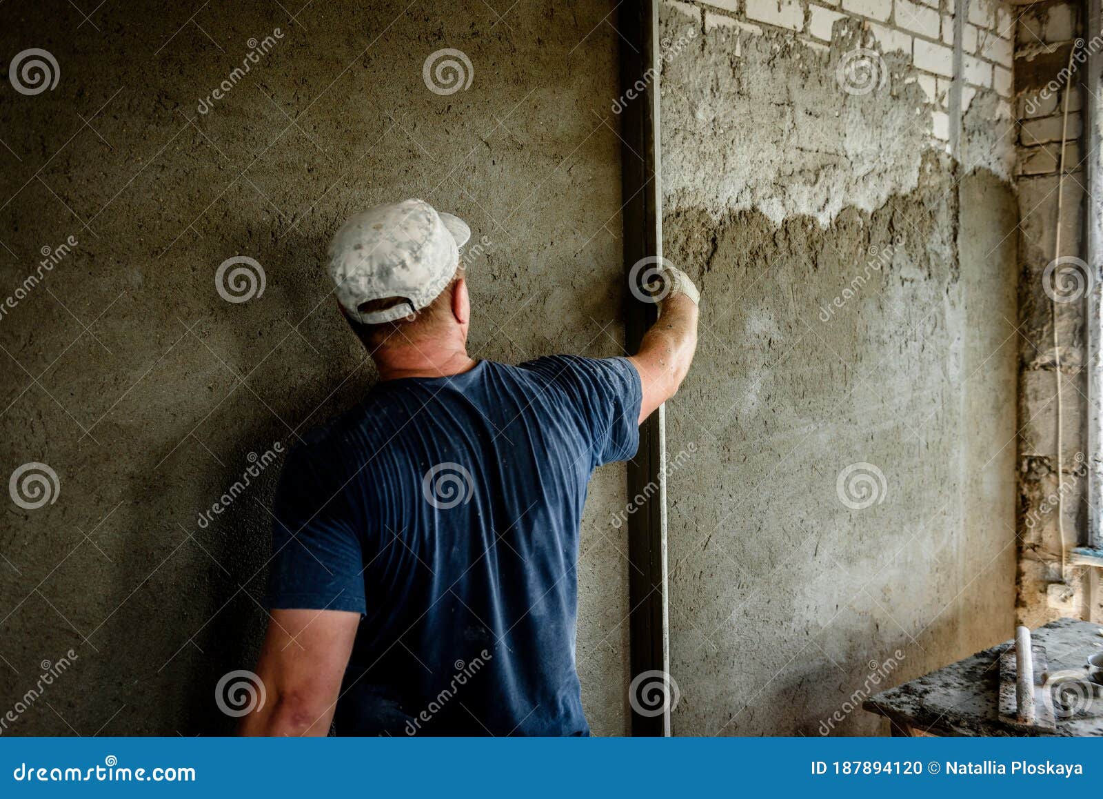 Construction Worker Plastering Wall with Leveler Stock Photo - Image of ...