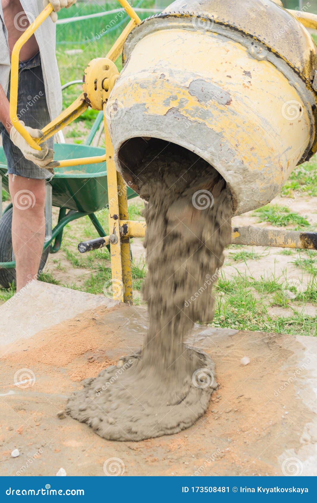 Construction Worker Poors Concrete Out of Concrete Mixer. Process of ...