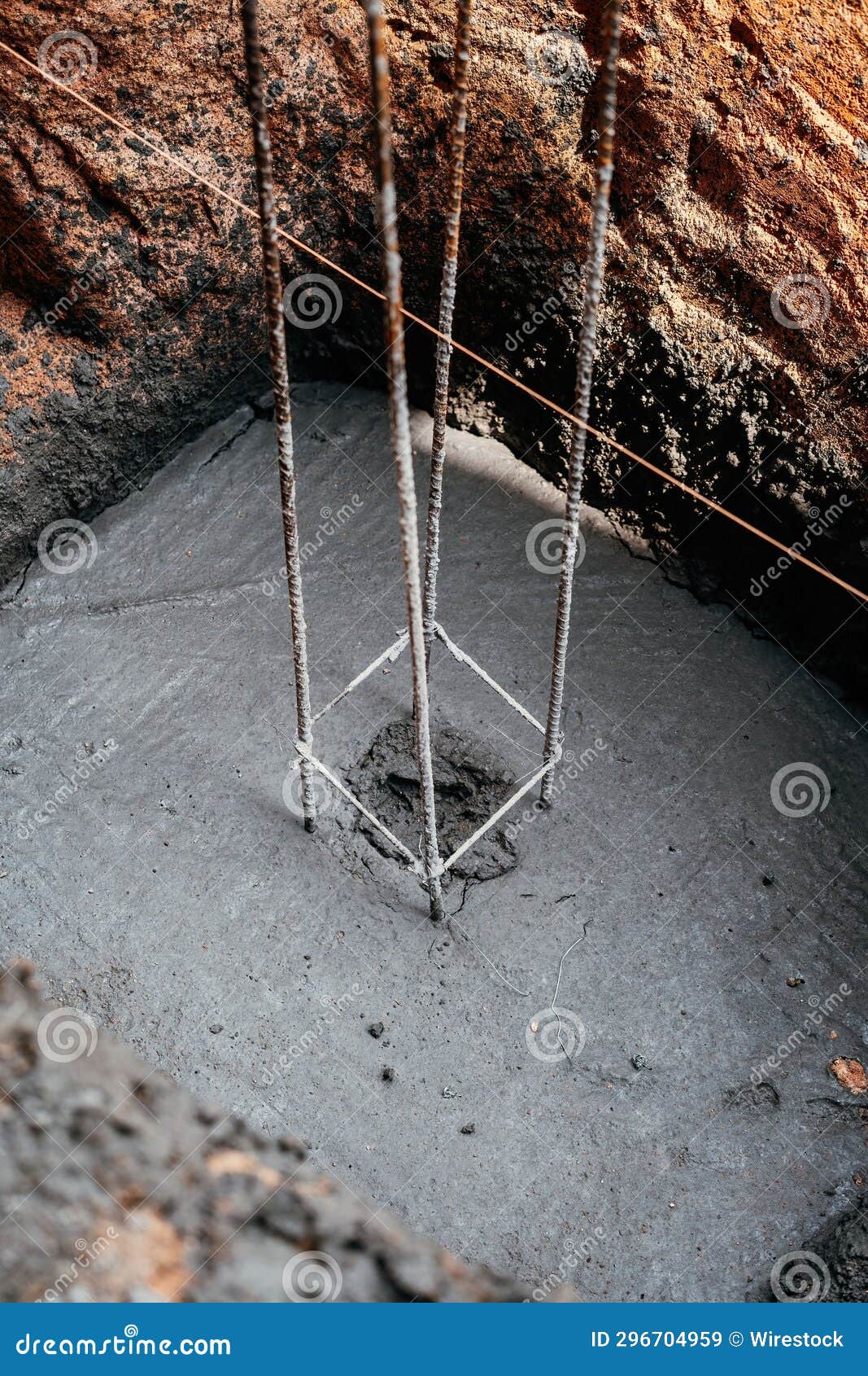 Construction Worker Pouring Cement into a Well at the Construction Site ...