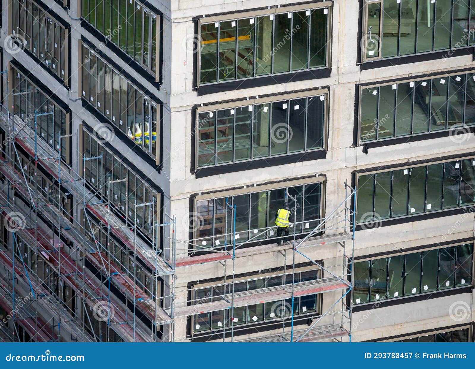 Construction Worker Removing the Scaffolding at a Commercial Building ...