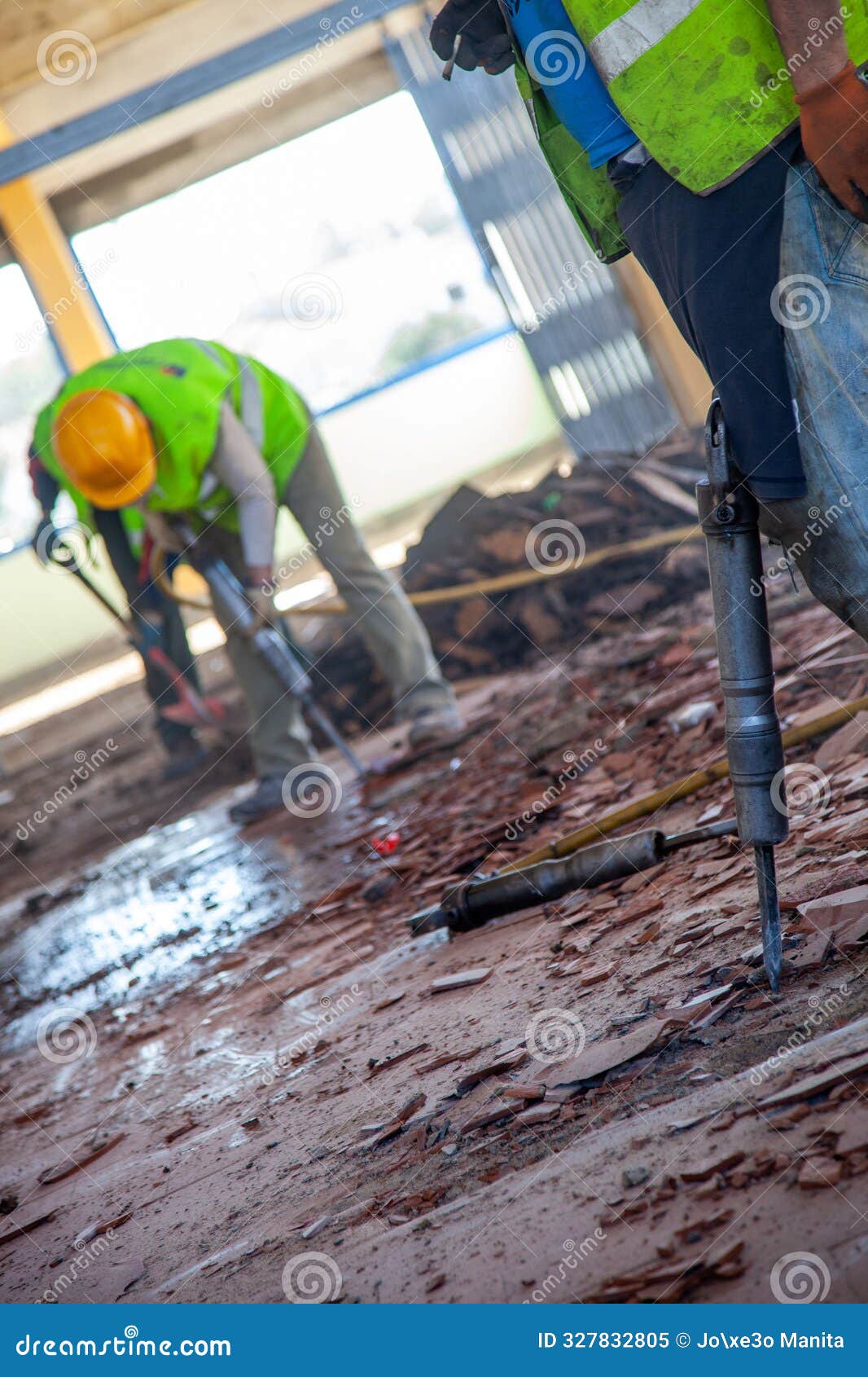 A Construction Worker on a Renovation Site Using a Pneumatic Hammer ...