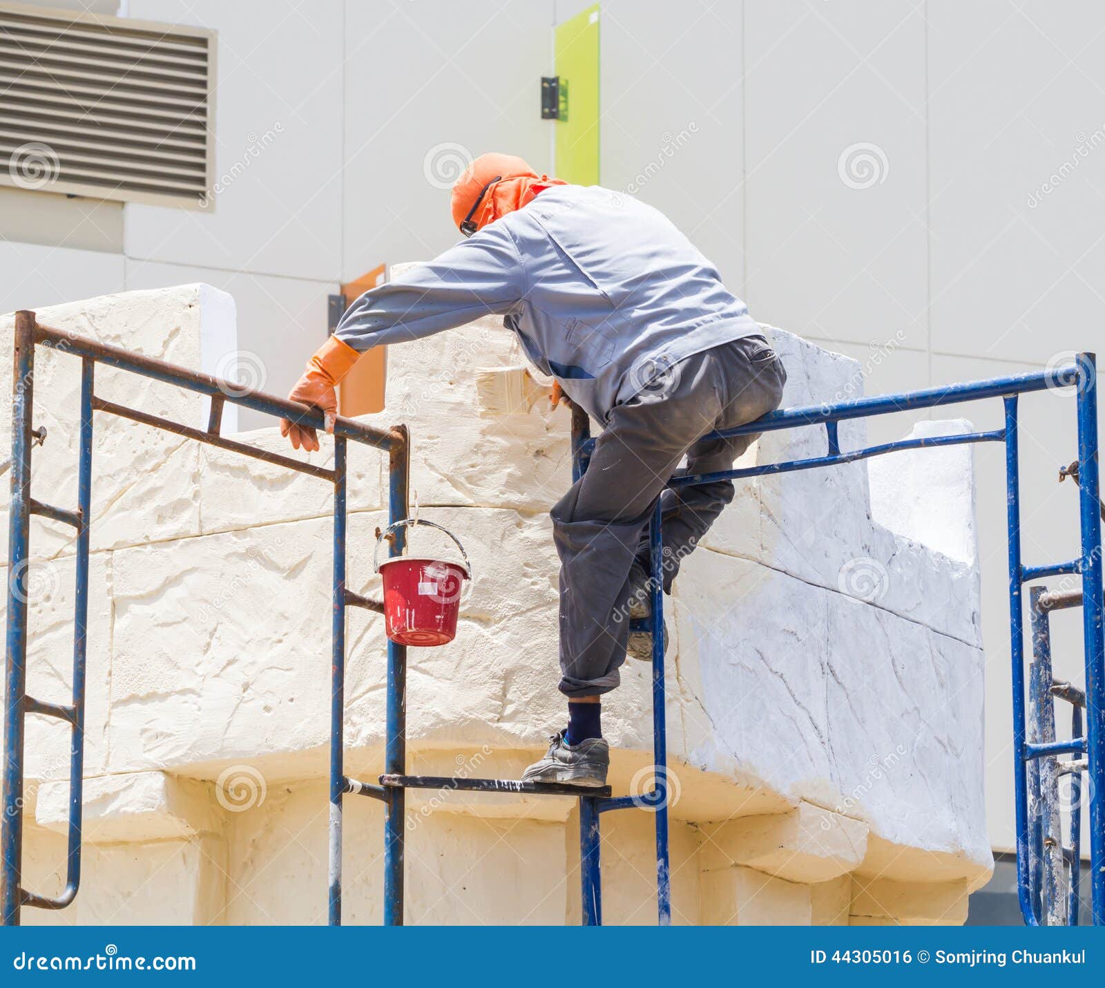 Construction Worker Restoring and Painting Outside the Building. Stock ...