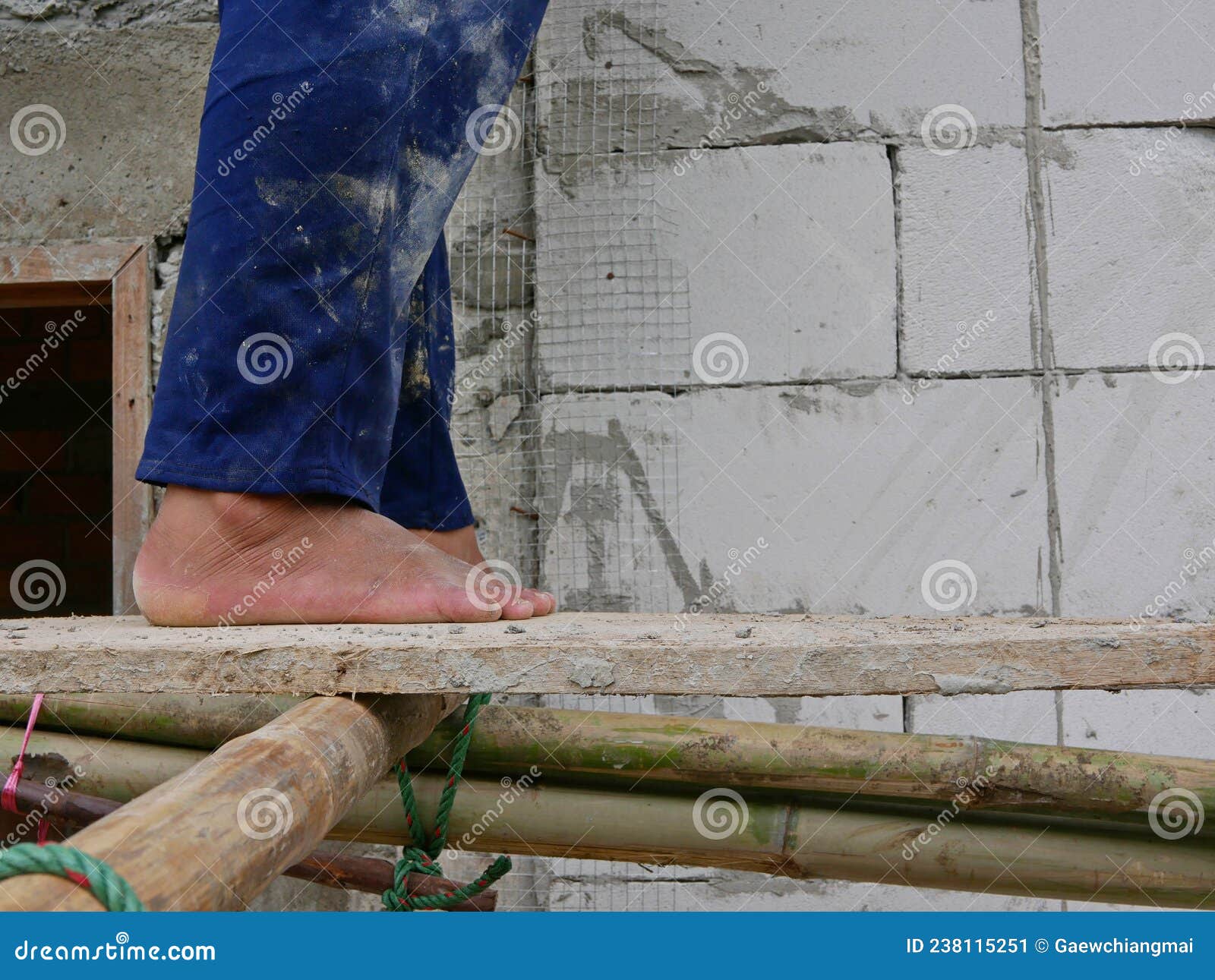 Construction Worker`s Bare Feet Standing On A Wood Plank On Bamboo ...