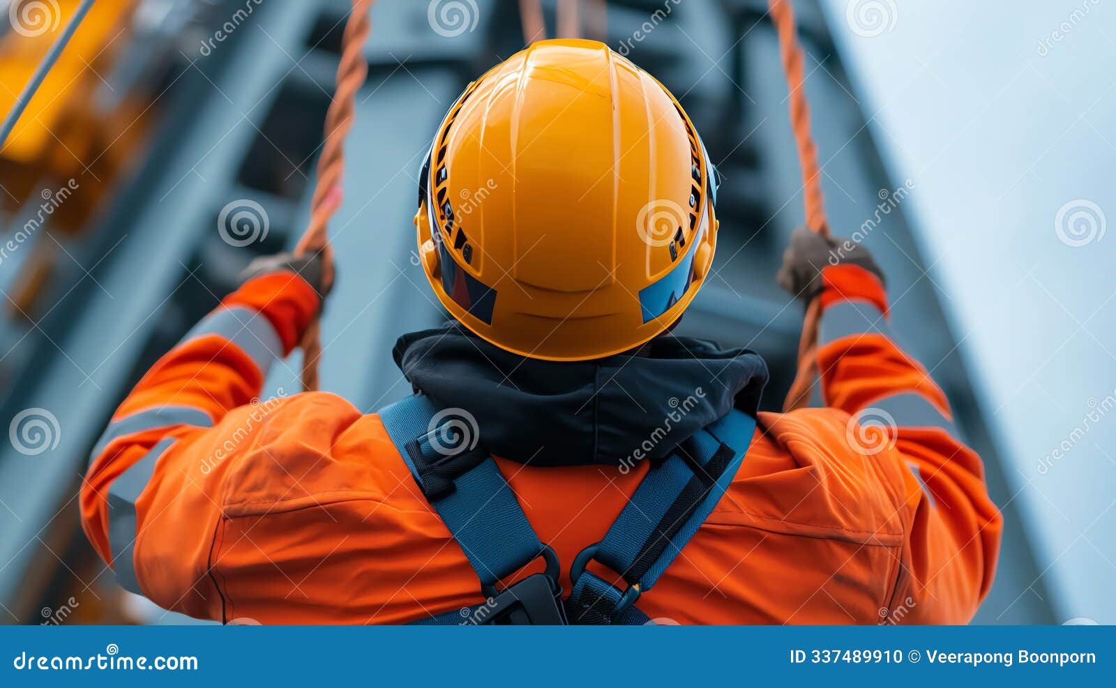 Construction Worker in Safety Gear Operating Machinery in a Dynamic ...