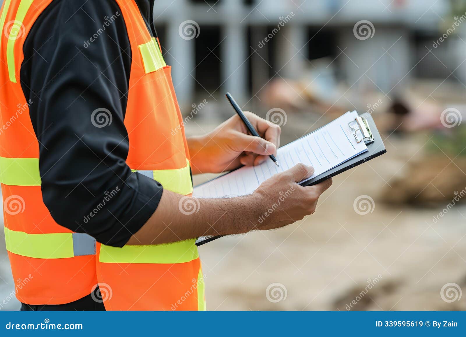 Construction Worker in Safety Vest Writing on Clipboard, Site ...
