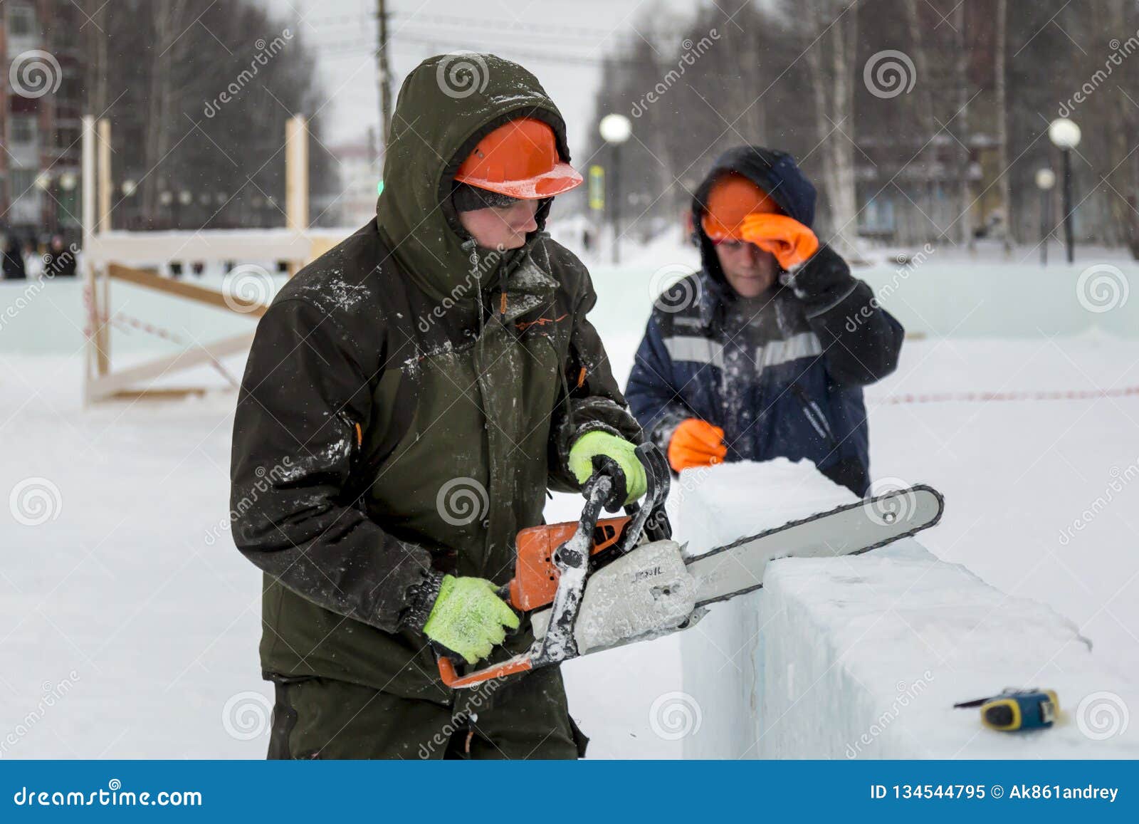 Worker Cuts a Lump of Ice with a Chainsaw Stock Image - Image of light ...