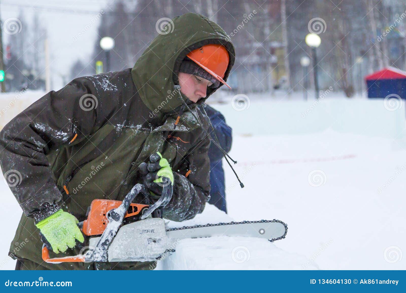 Worker Cuts a Lump of Ice with a Chainsaw Stock Photo - Image of ...