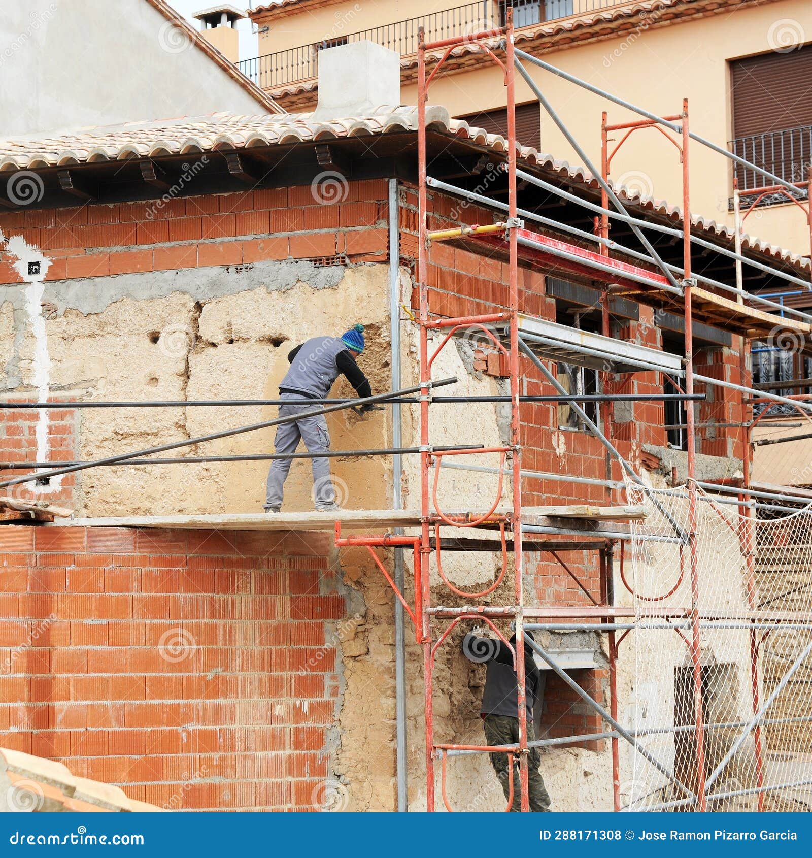 Construction Worker on Scaffold Using the Pickaxe in an Old Wall. Stock ...