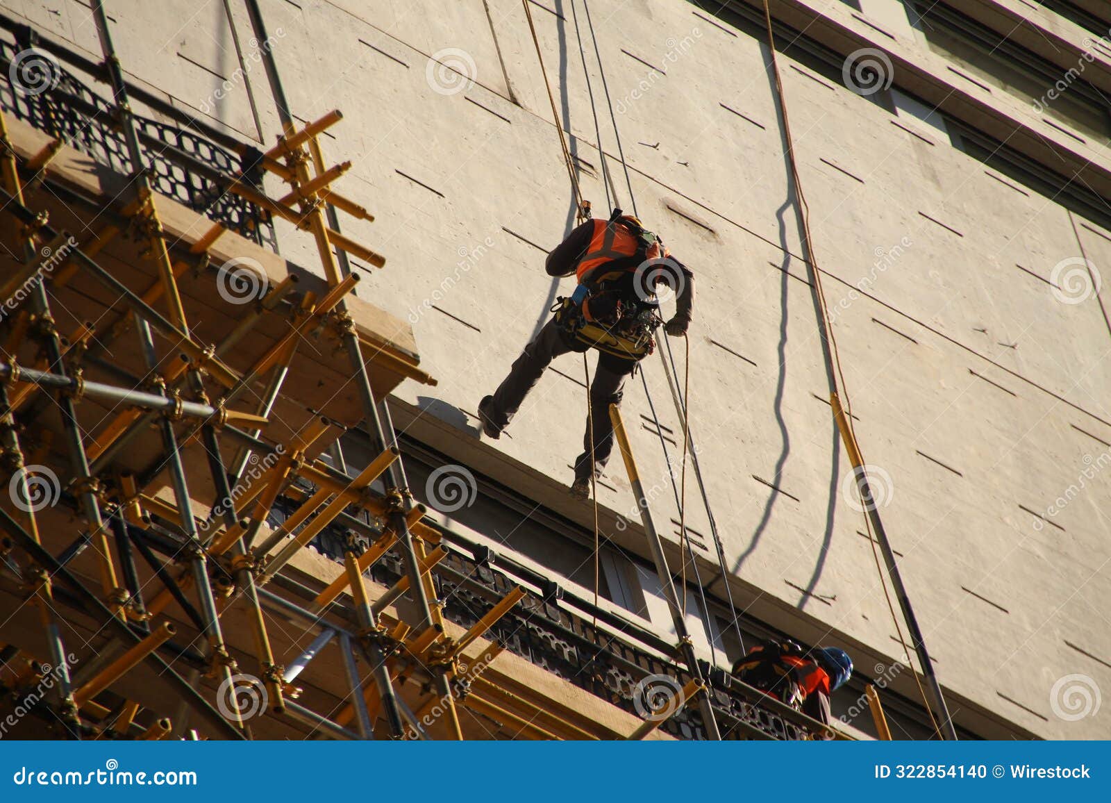 Construction Worker on a Scaffold Working on a Building S Side Stock ...