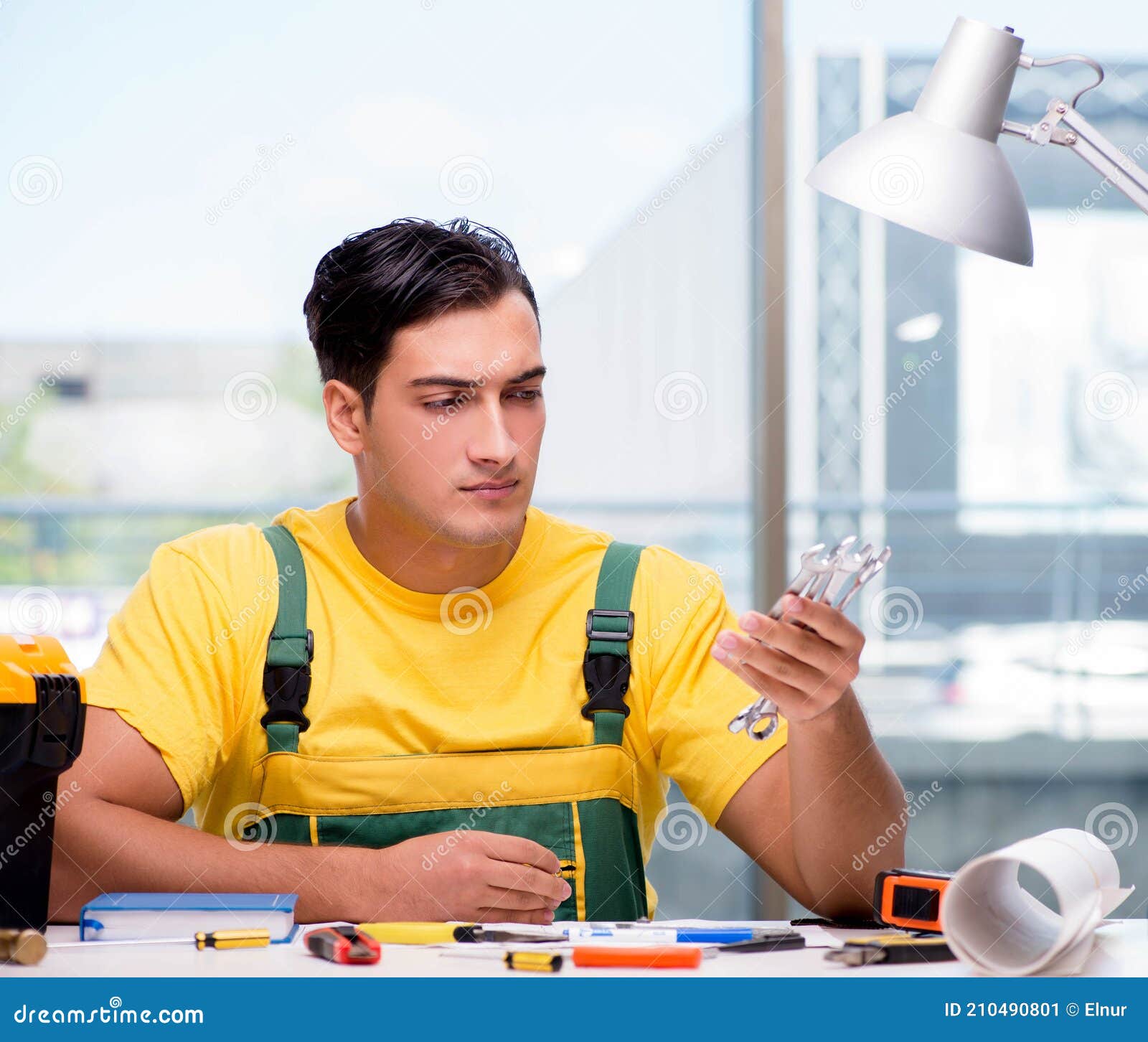 Construction Worker Sitting at the Desk Stock Image - Image of overalls ...
