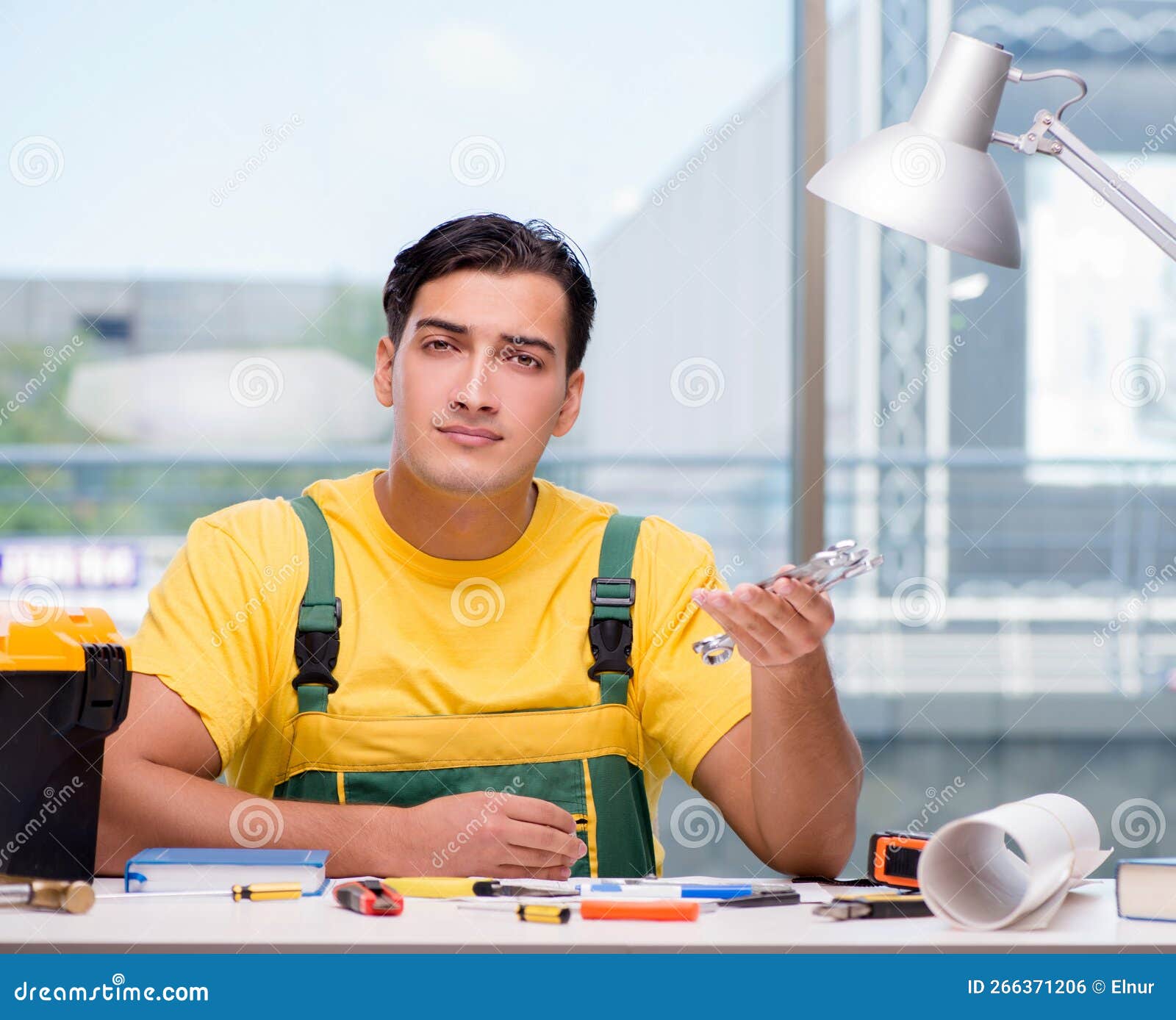 Construction Worker Sitting at the Desk Stock Photo - Image of overalls ...