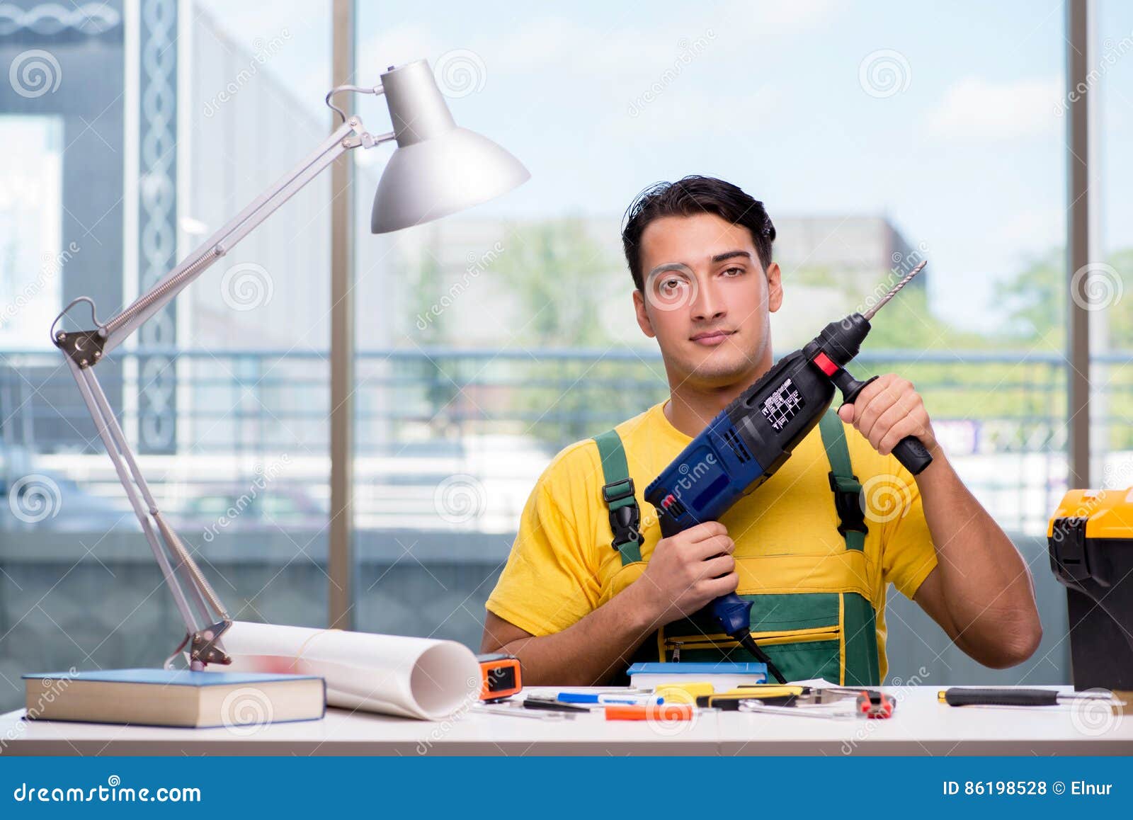 The Construction Worker Sitting at the Desk Stock Photo - Image of home ...