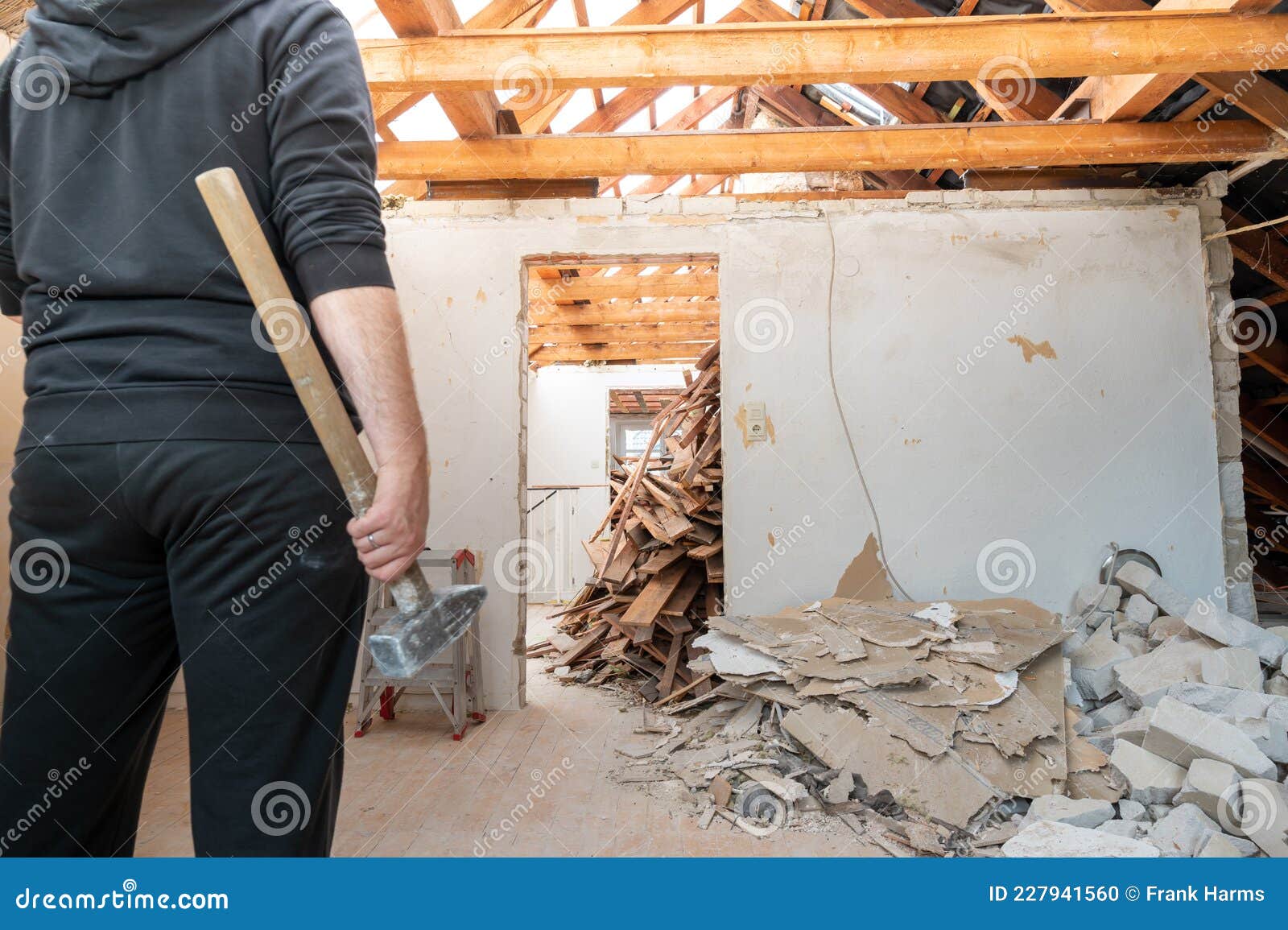 Construction Worker with a Sledge Hammer after Demolishing a Brick Wall ...