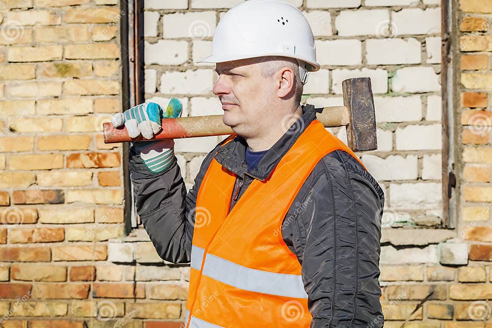Construction Worker with Sledgehammer Near the Brick Wall Stock Photo ...