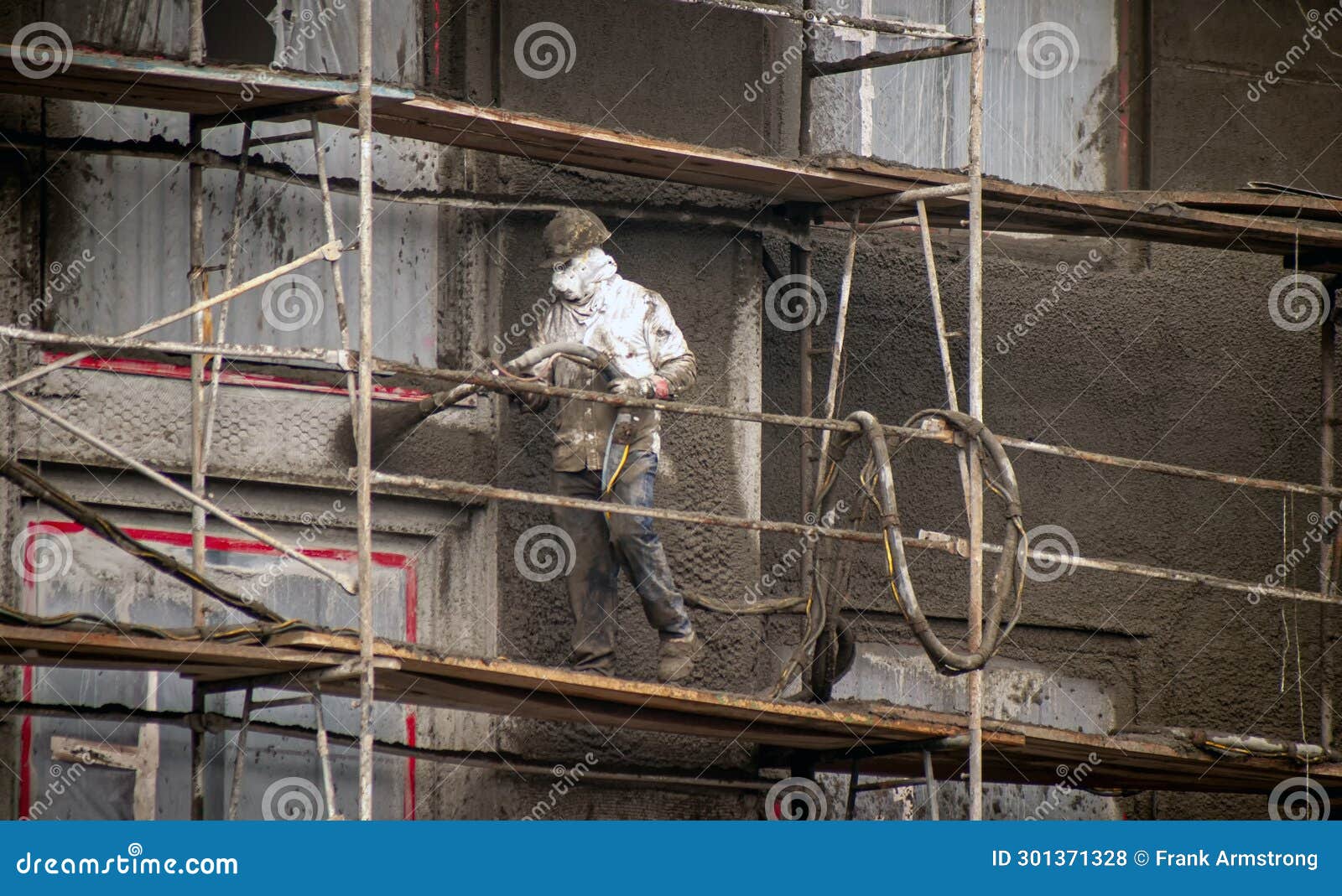 Construction Worker Spraying Stucco on the Exterior of a Building Stock ...