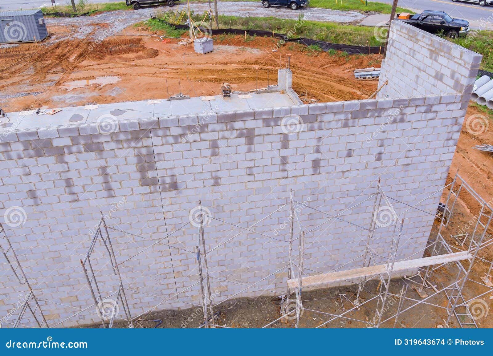 Construction Worker Standing on Scaffold Makes a Working Concrete Wall ...