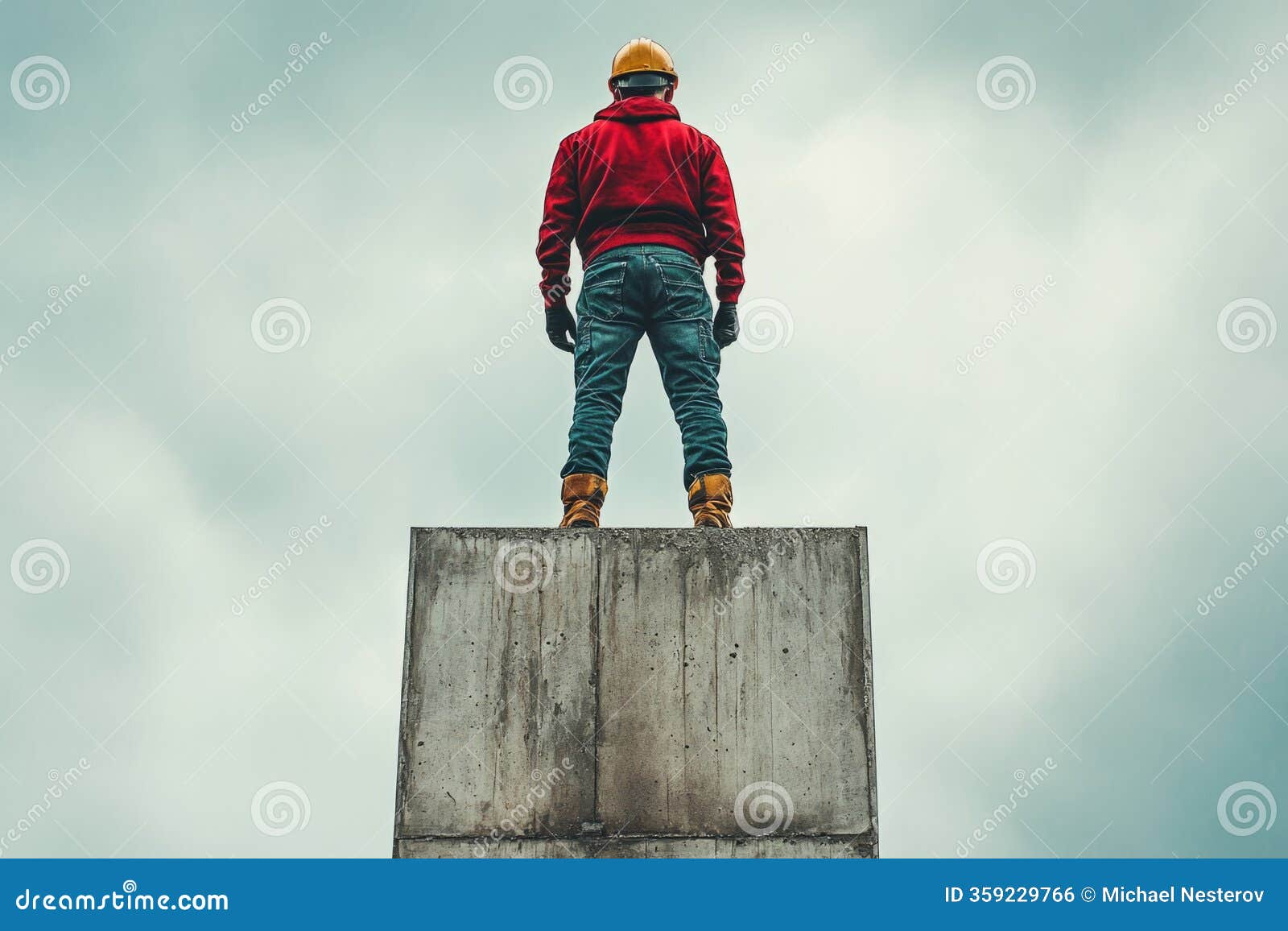 Construction Worker Standing on Top of Concrete Structure, Symbolizing ...