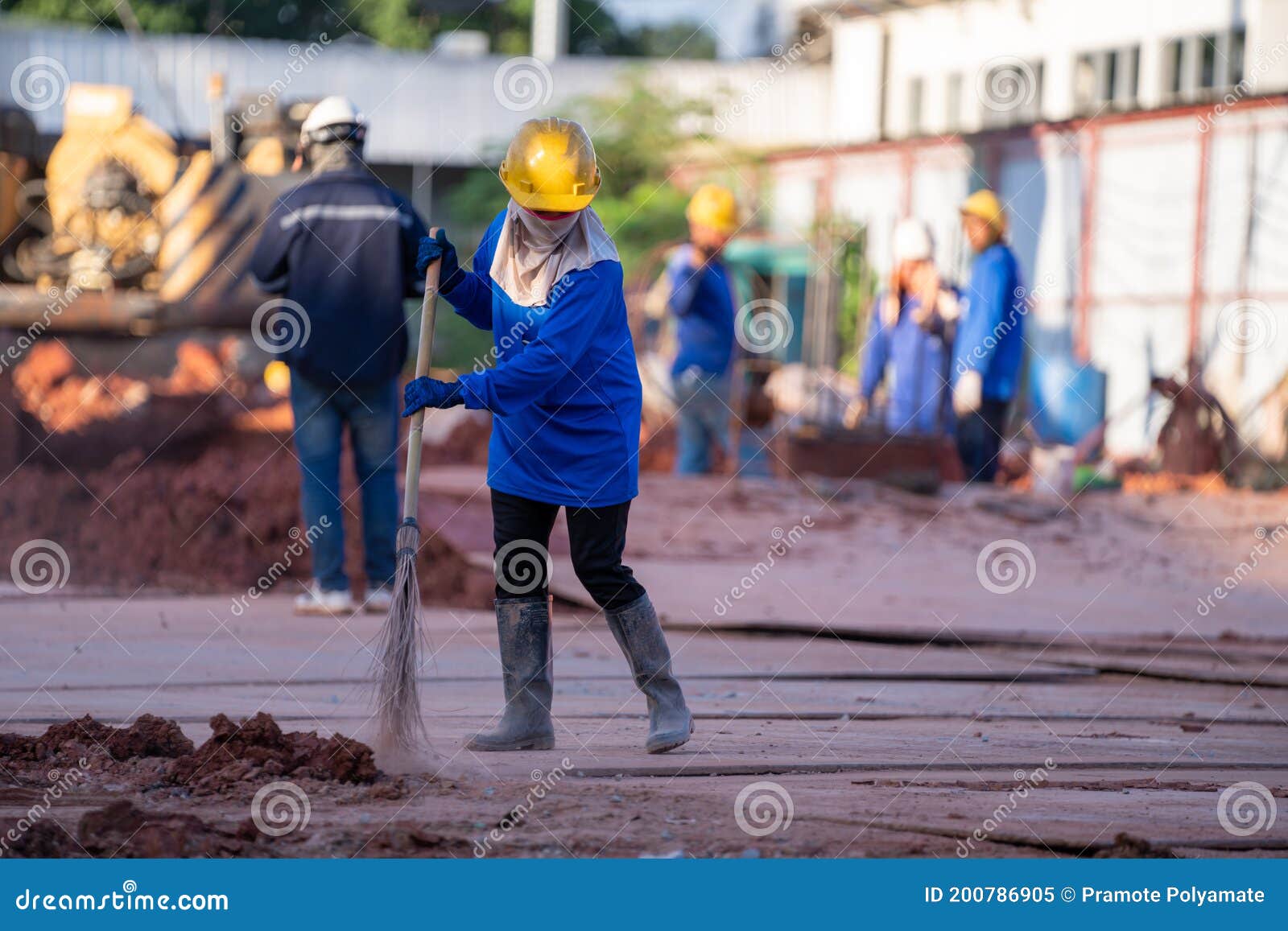 Construction Worker Sweepers Soil Debris with Brush Broom in the ...