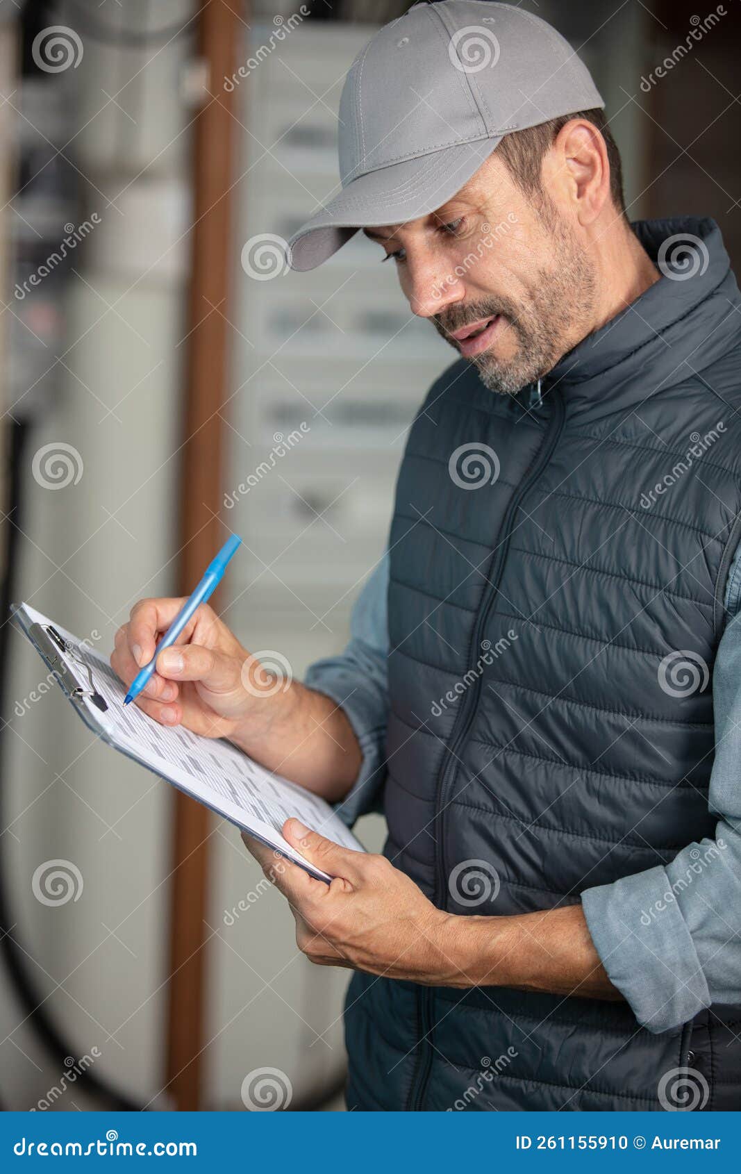 Construction Worker Taking Notes on Clipboard in New House Stock Photo ...