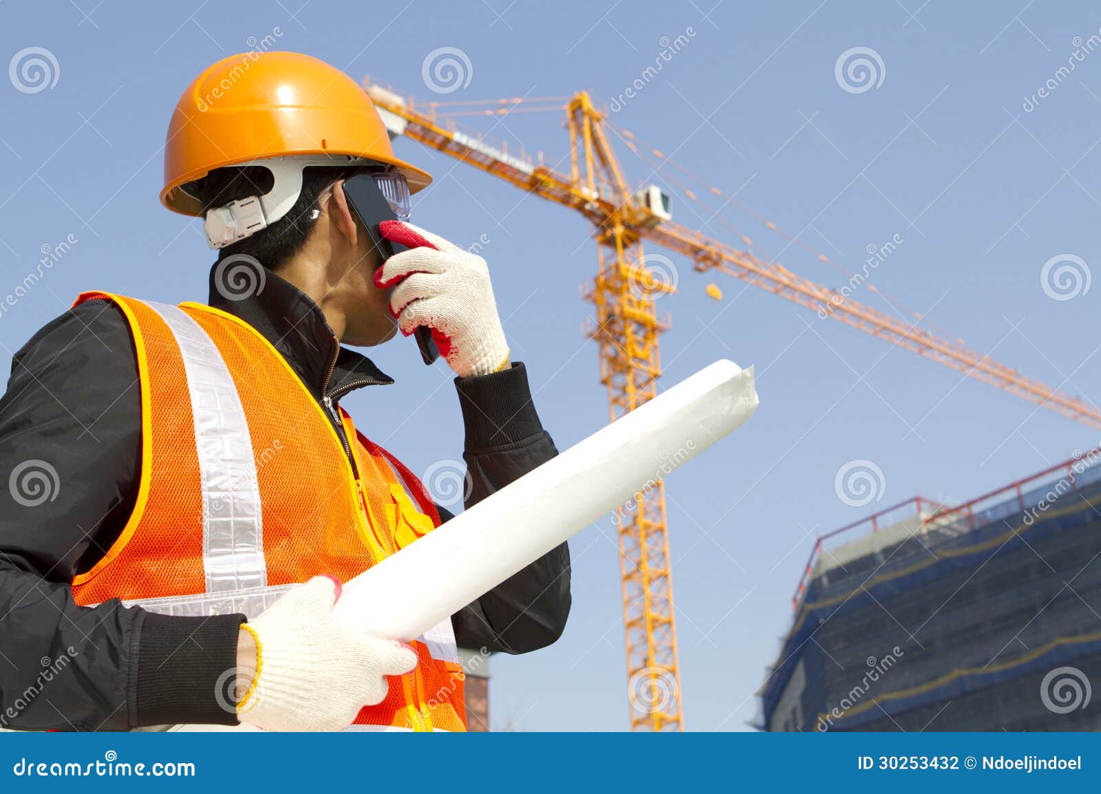 Construction Worker with Crane in Background Stock Photo - Image of ...