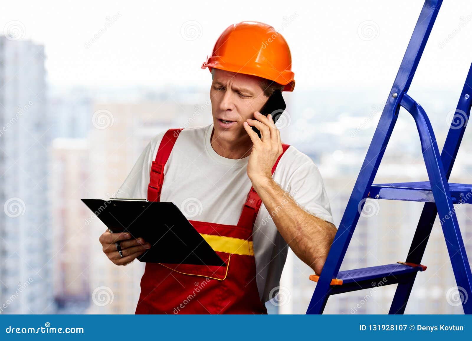 Construction Worker Talking On Smartphone. Stock Image - Image of ...