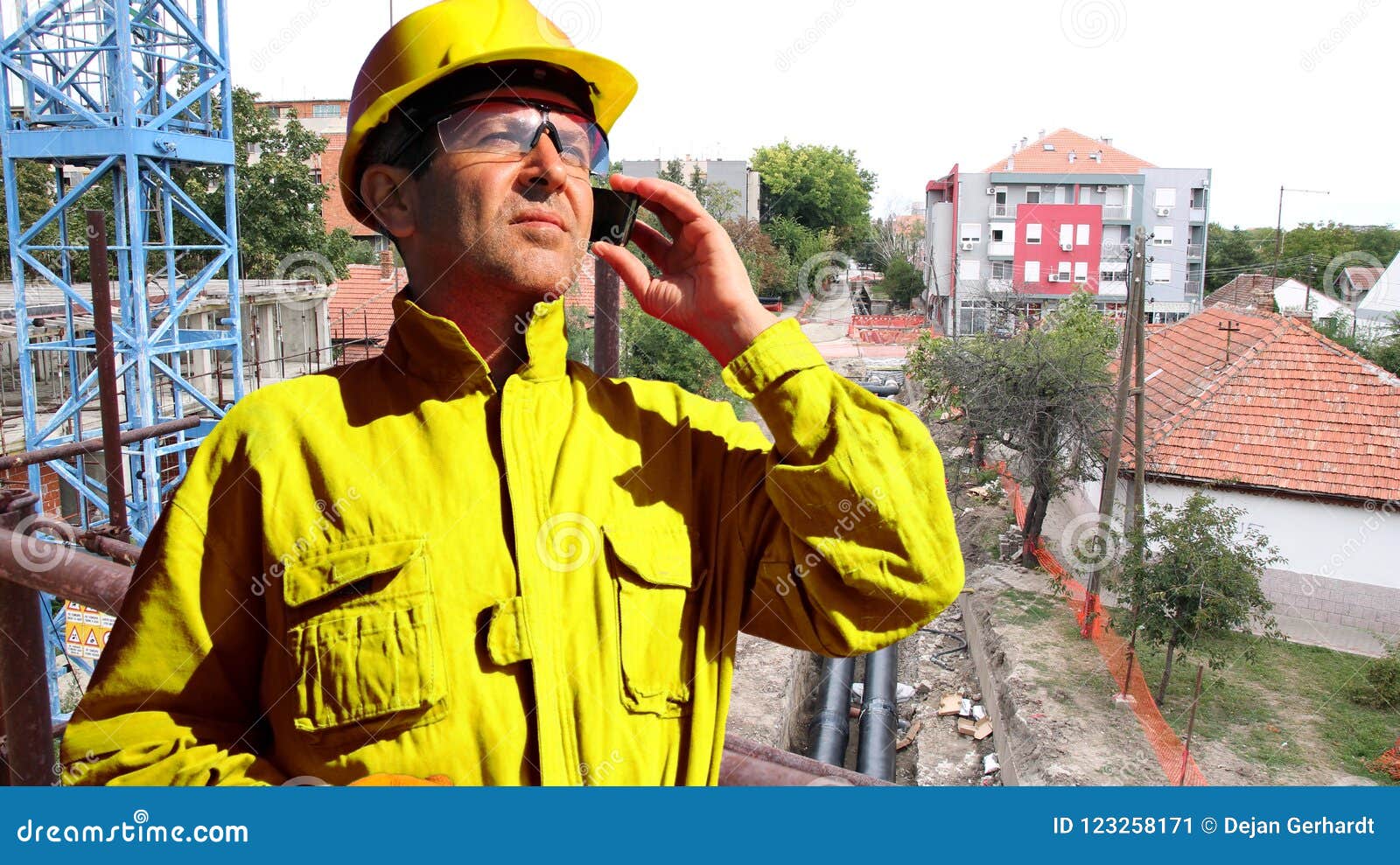 Construction Worker Talking on the Smartphone at Construction Site ...