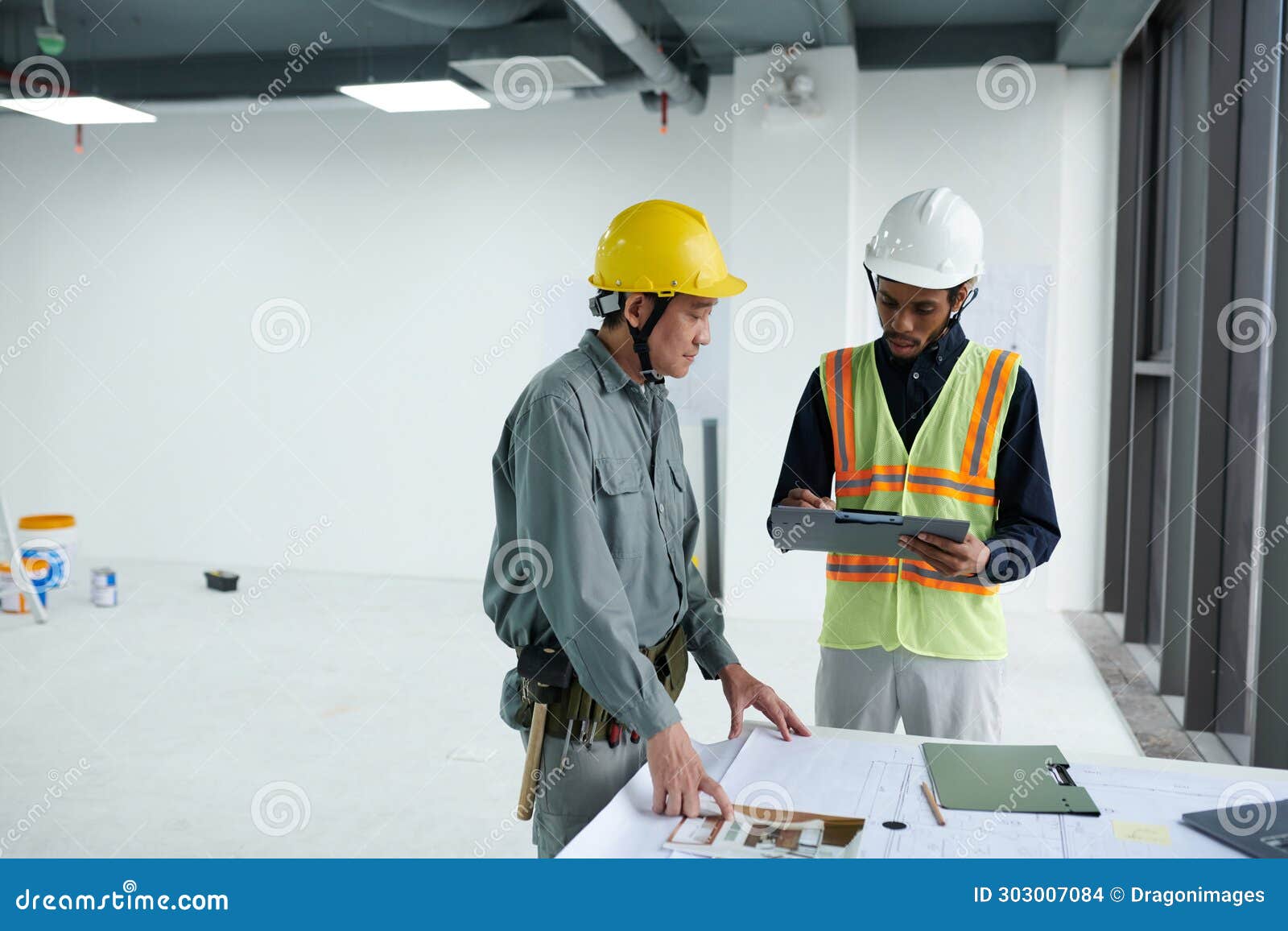 Construction Worker Talking To Builder Stock Photo - Image of diverse ...