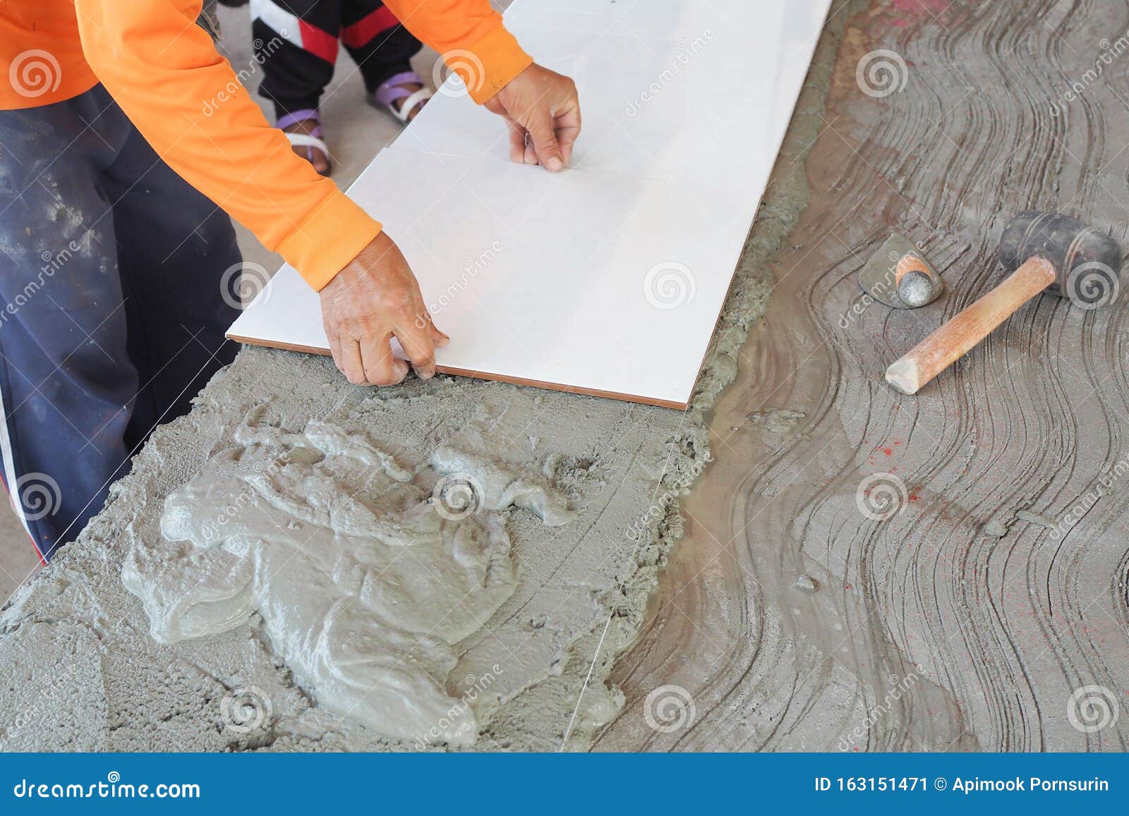 Construction Worker Tiler is Tiling, Tiler Installing Ceramic Tiles on ...