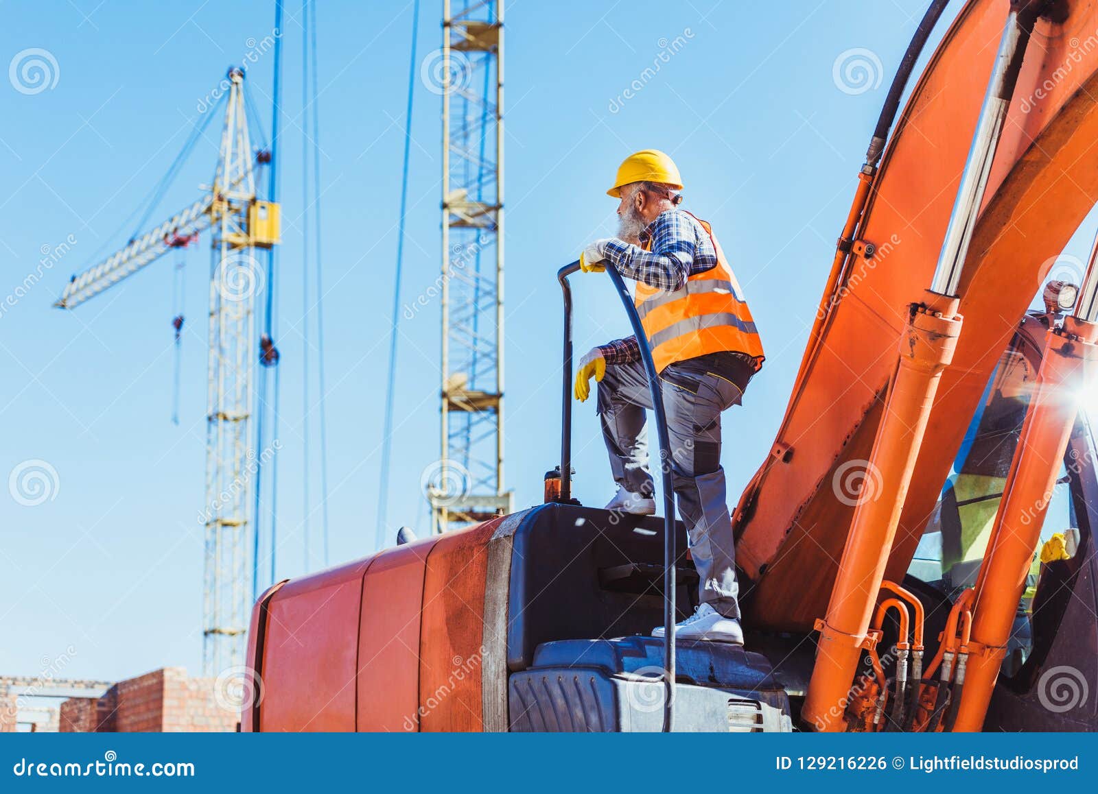 Construction Worker on Top of Excavator Cabin Stock Photo - Image of ...
