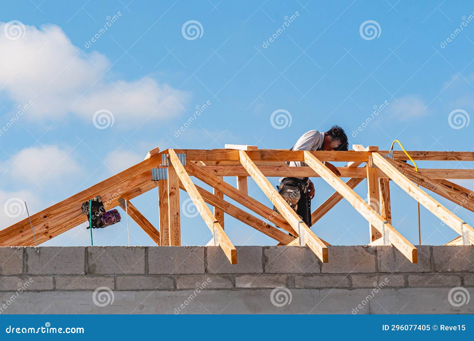 Construction Worker, Tying Trusses Together, for Greater Structural ...