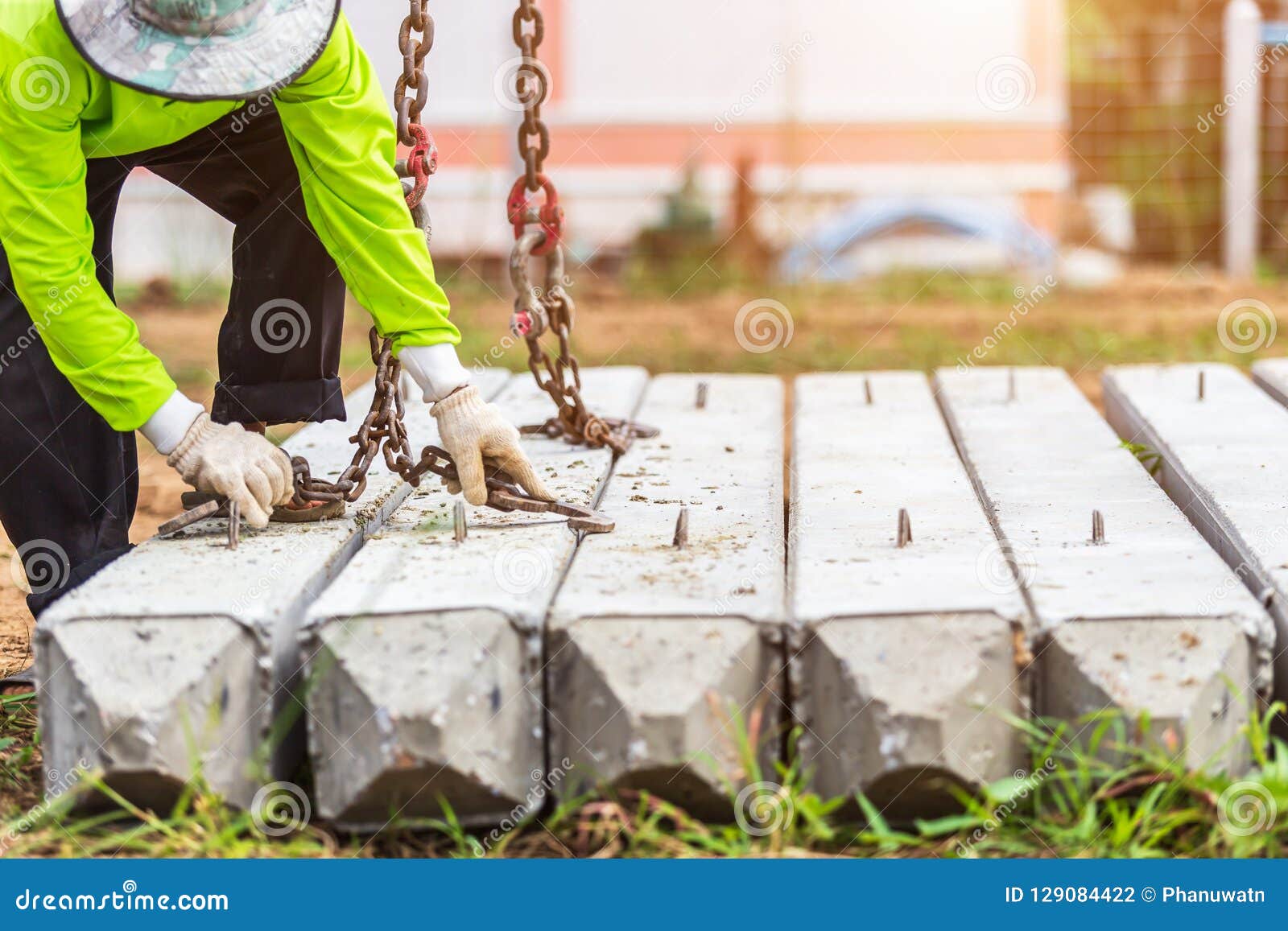 Construction Worker Unloading Concrete Stake from Truck Stock Photo ...