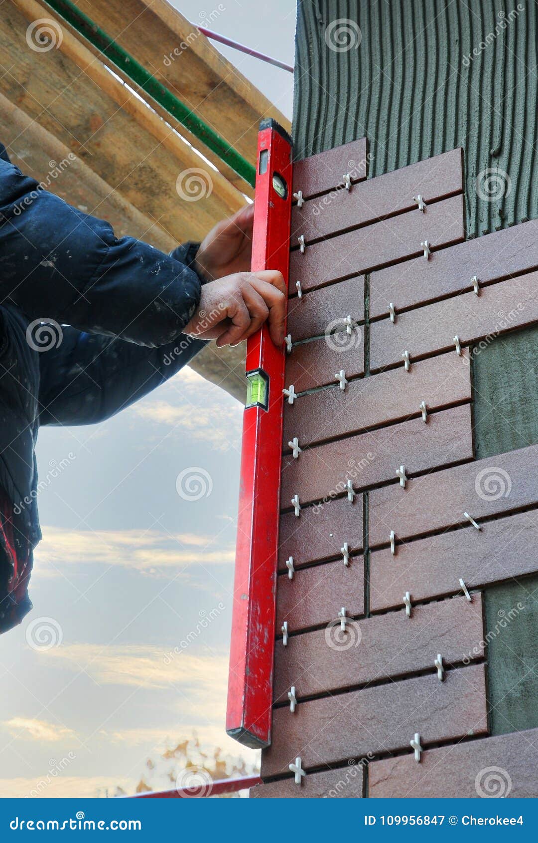 Construction Worker Use a Spirit Level To Check Decorative Tiles on the ...