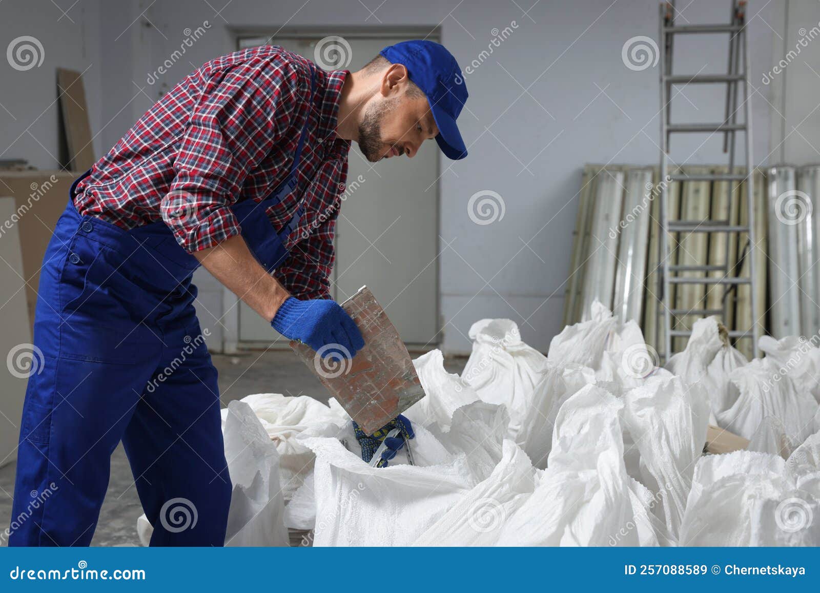 Construction Worker with Used Building Materials in Room Prepared for ...