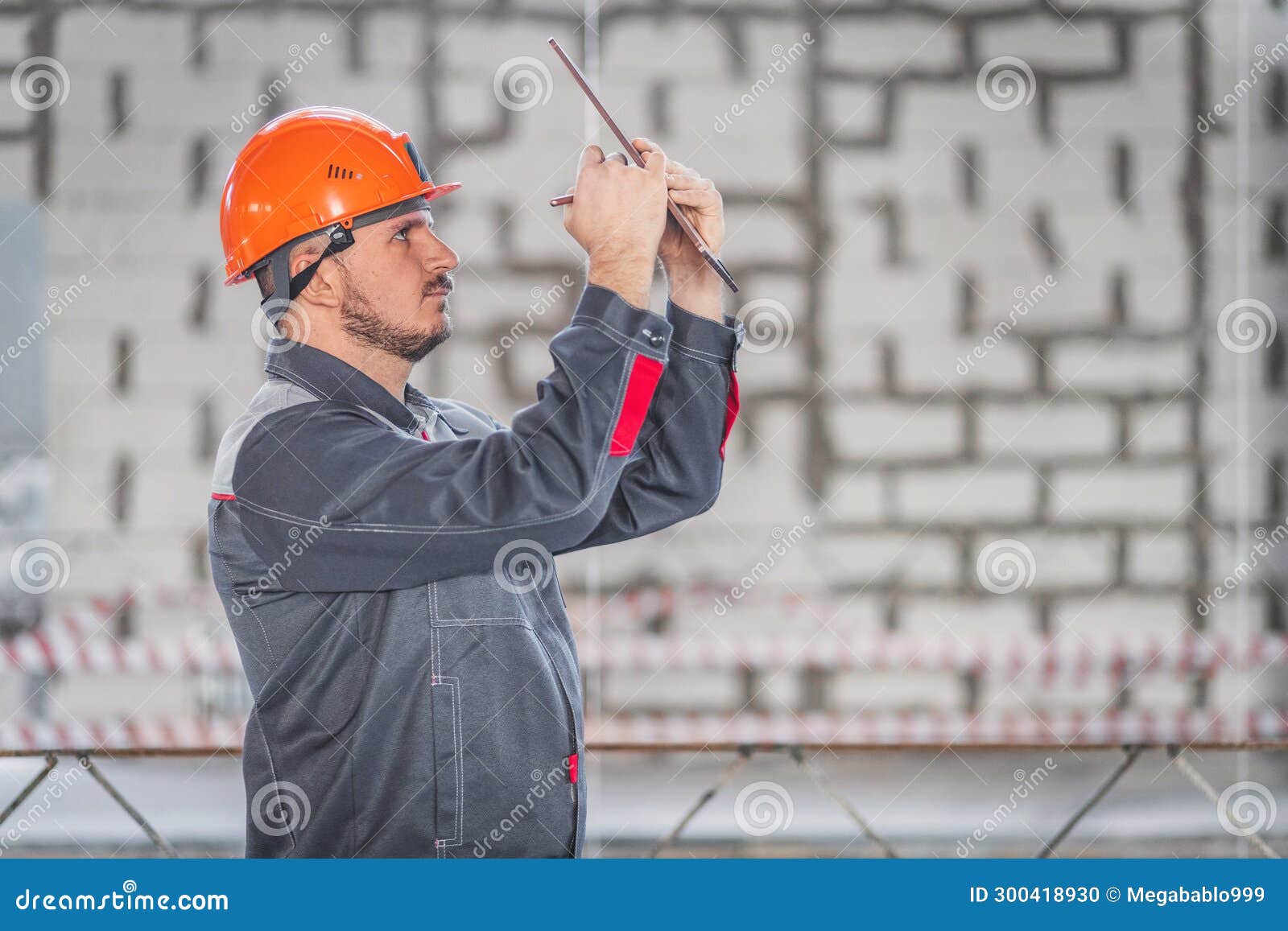 A Construction Worker Uses Modern Digital Technologies in the Process ...