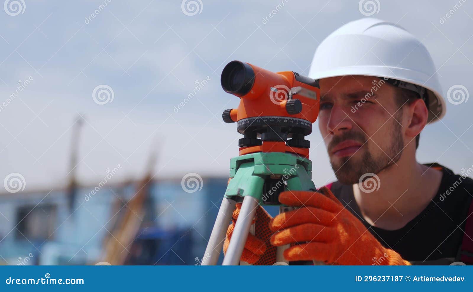 Construction Worker Uses Optical Level on Construction Site. Civil ...
