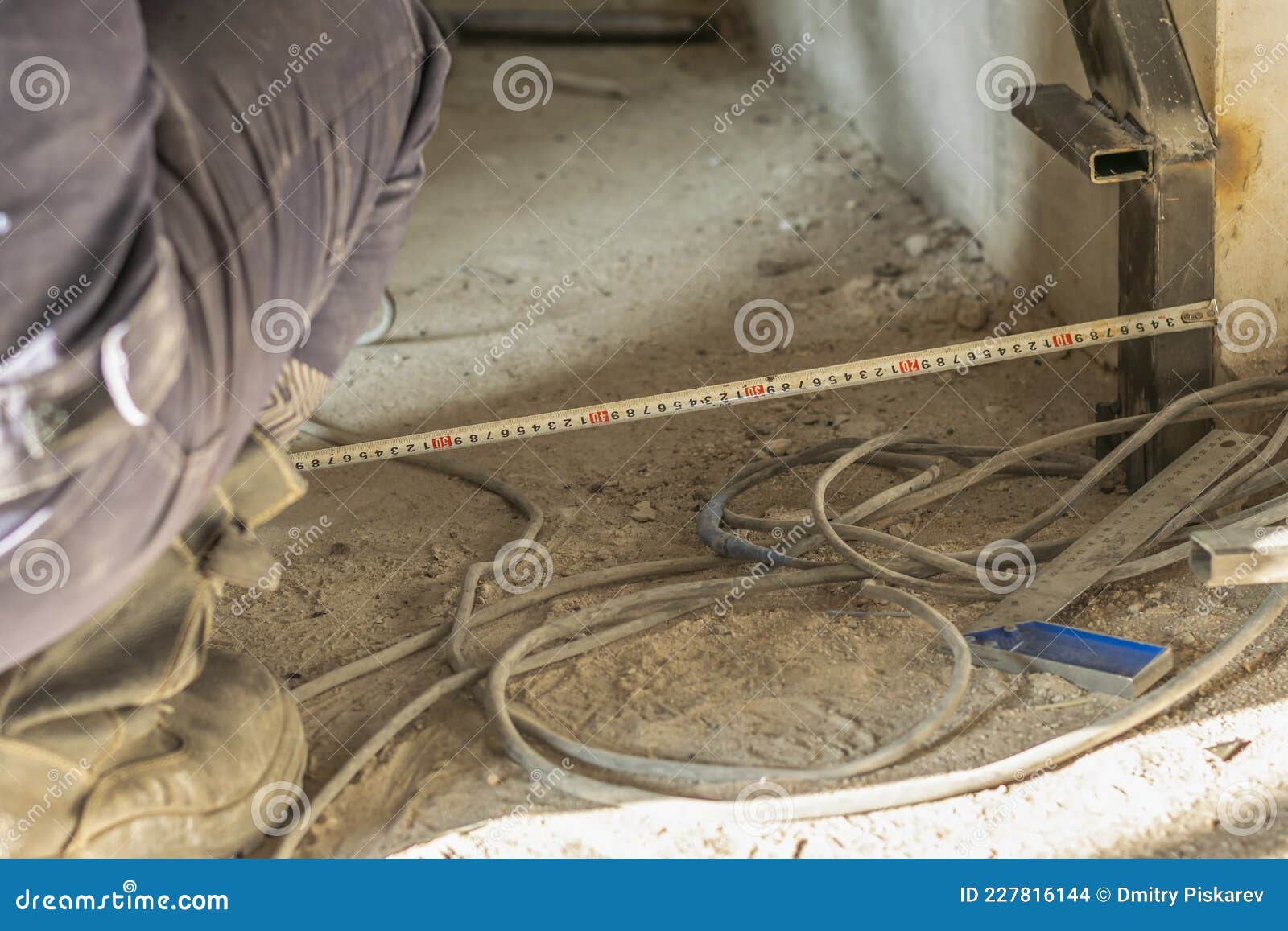 A Construction Worker Uses a Ruler To Measure the Dimensions of the ...