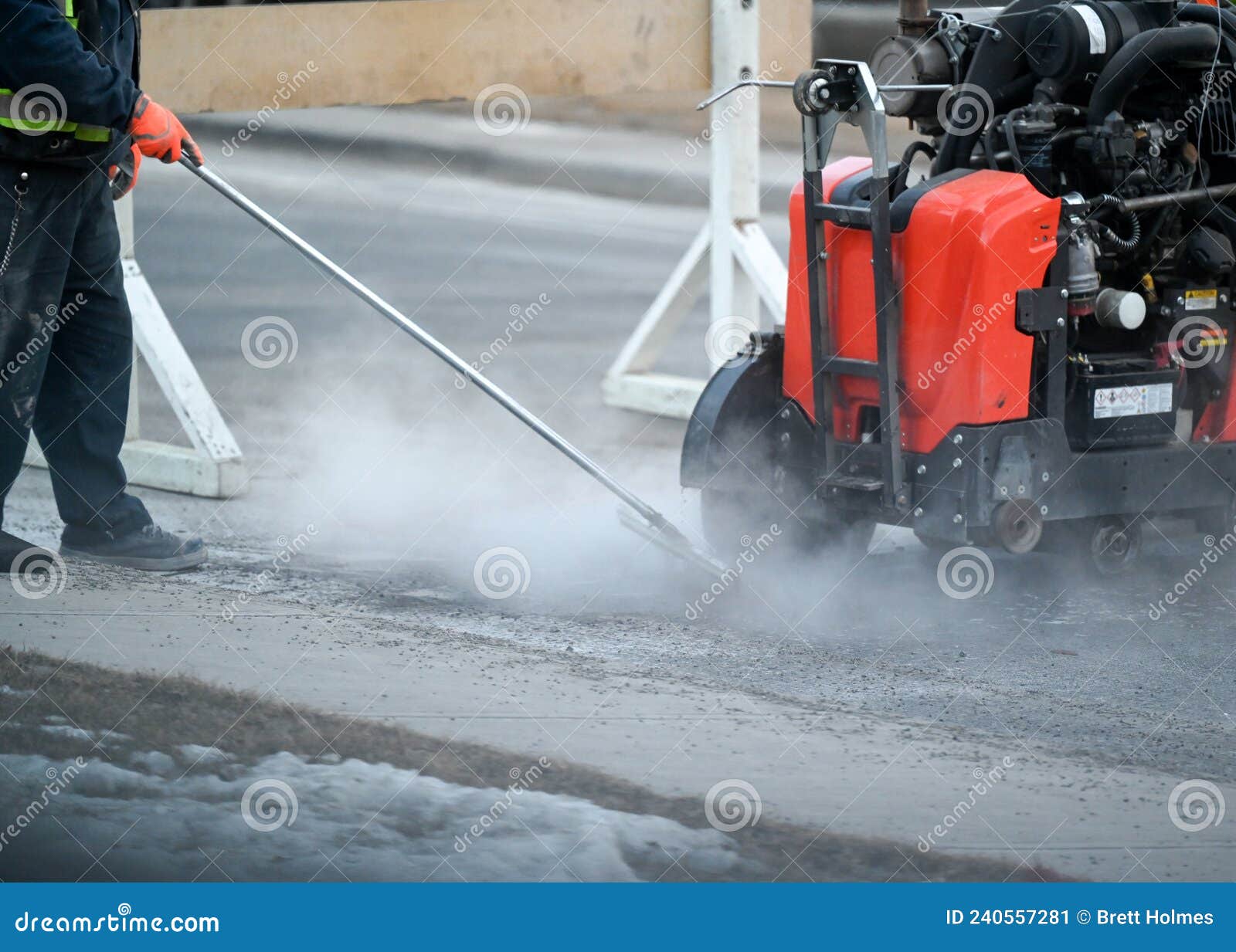 Construction Worker Using an Asphalt Saw Cutting Machine To Excavate ...