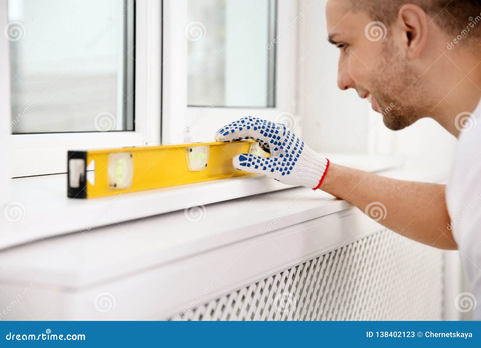 Construction Worker Using Bubble Level while Installing Window Indoors ...
