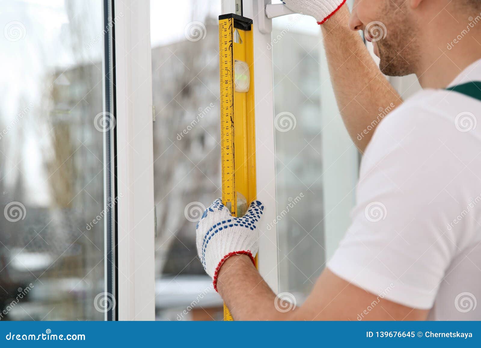 Construction Worker Using Bubble Level while Installing Window Indoors ...