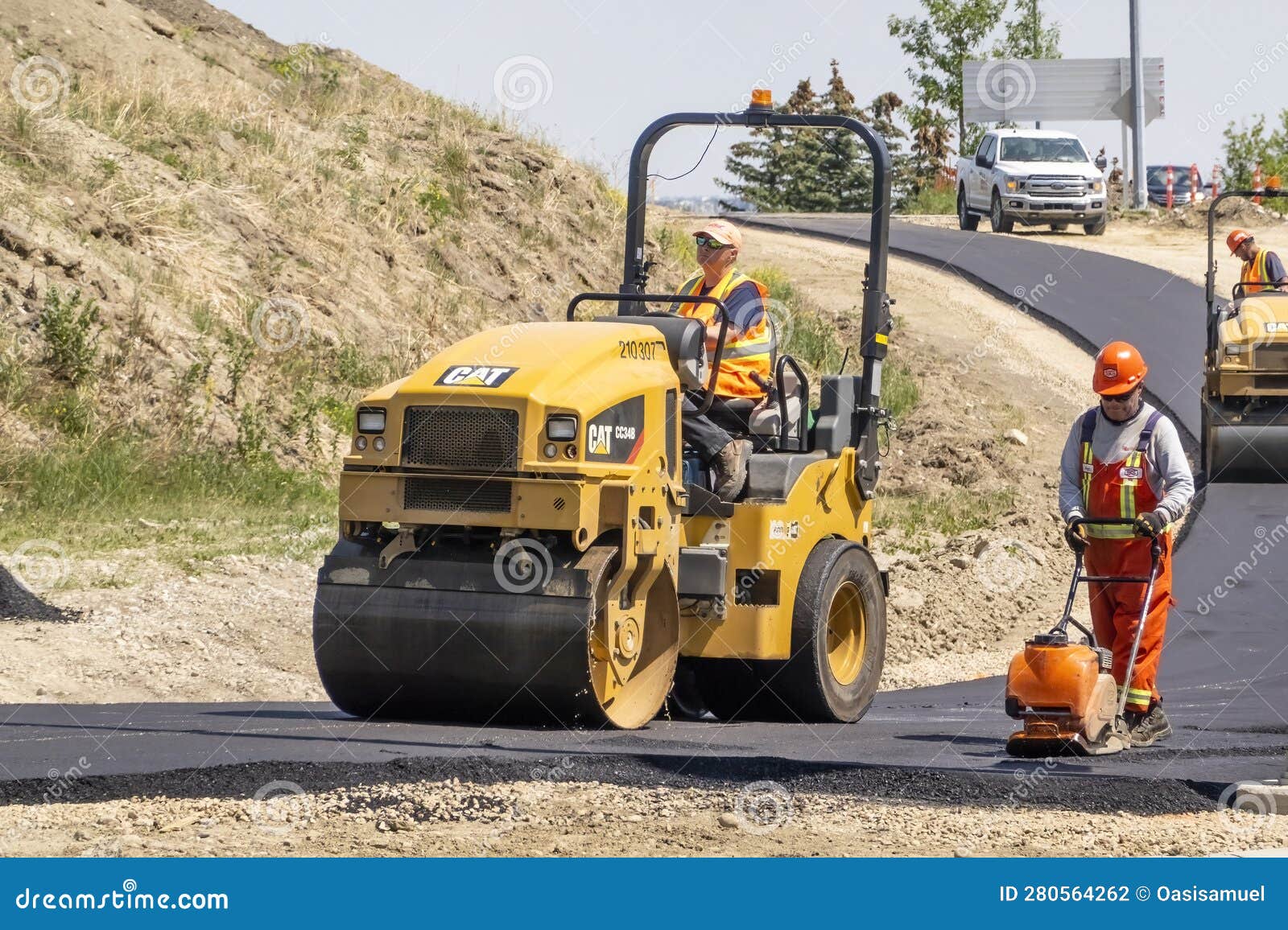 A Construction Worker Using a Cat Tandem Vibratory Roller. Use To ...