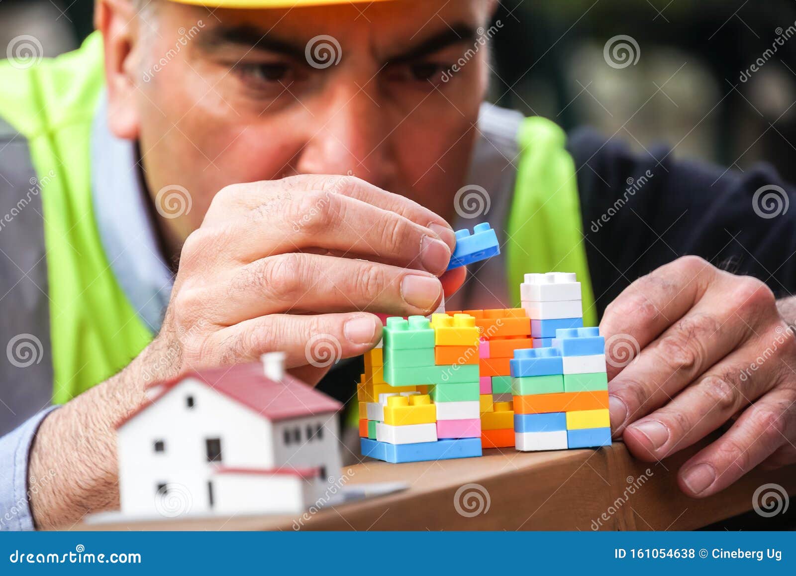 Construction Worker Using Colourful Toy Bricks Stock Photo - Image of ...