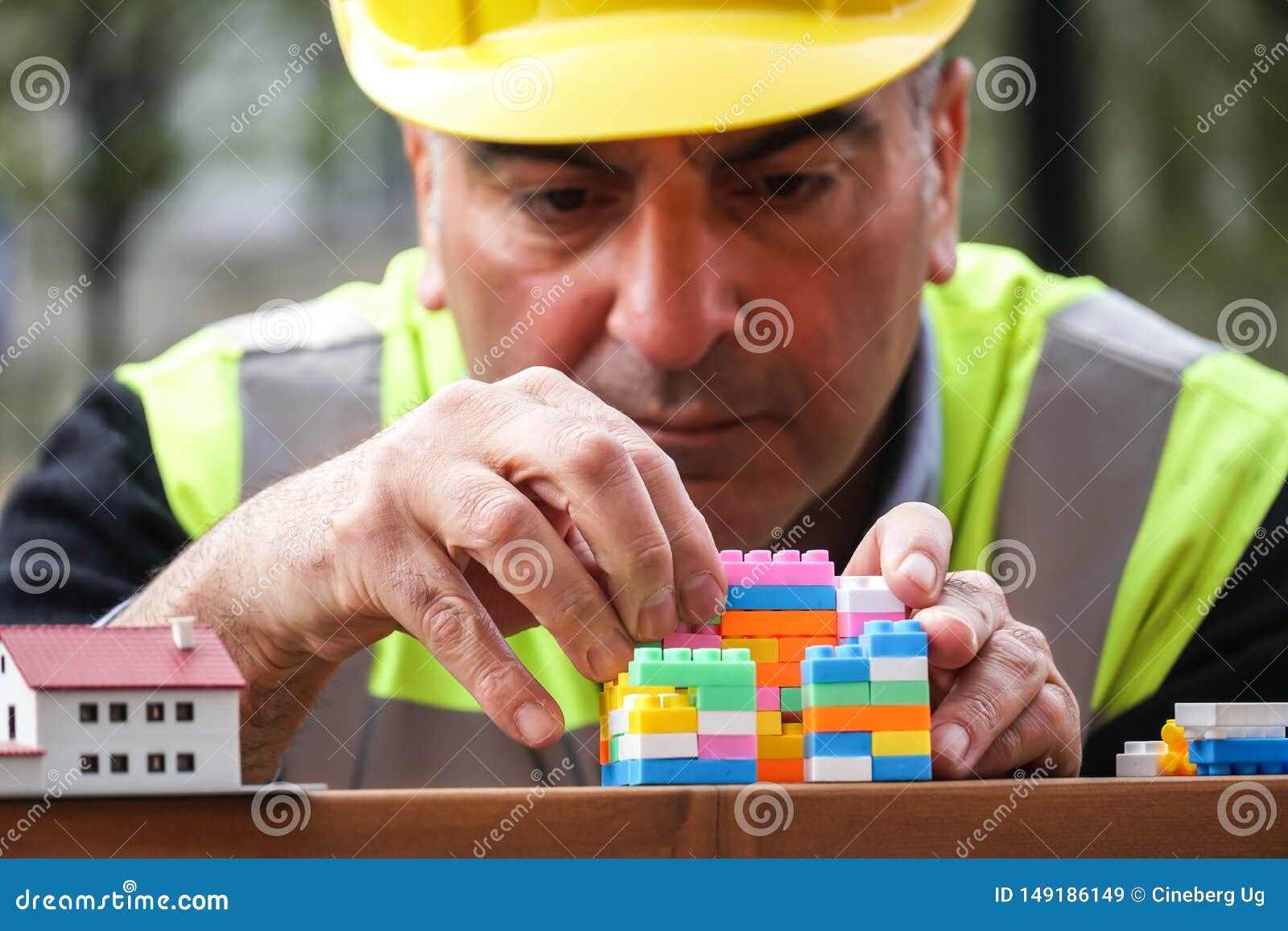 Construction Worker Using Colourful Toy Bricks Stock Image - Image of ...
