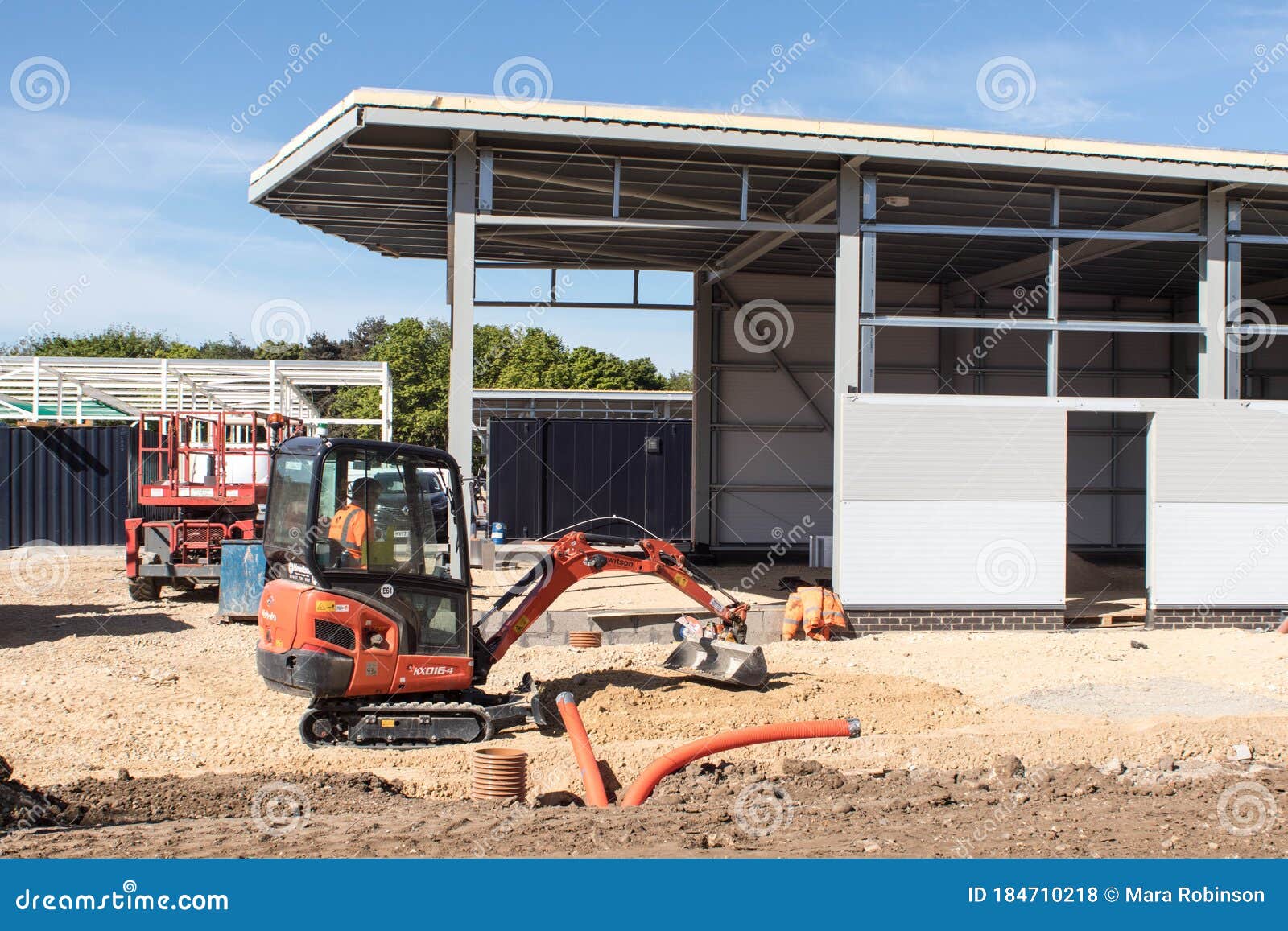 A Worker Using A Telescopic Forklift Raises A Load Of Bricks During ...