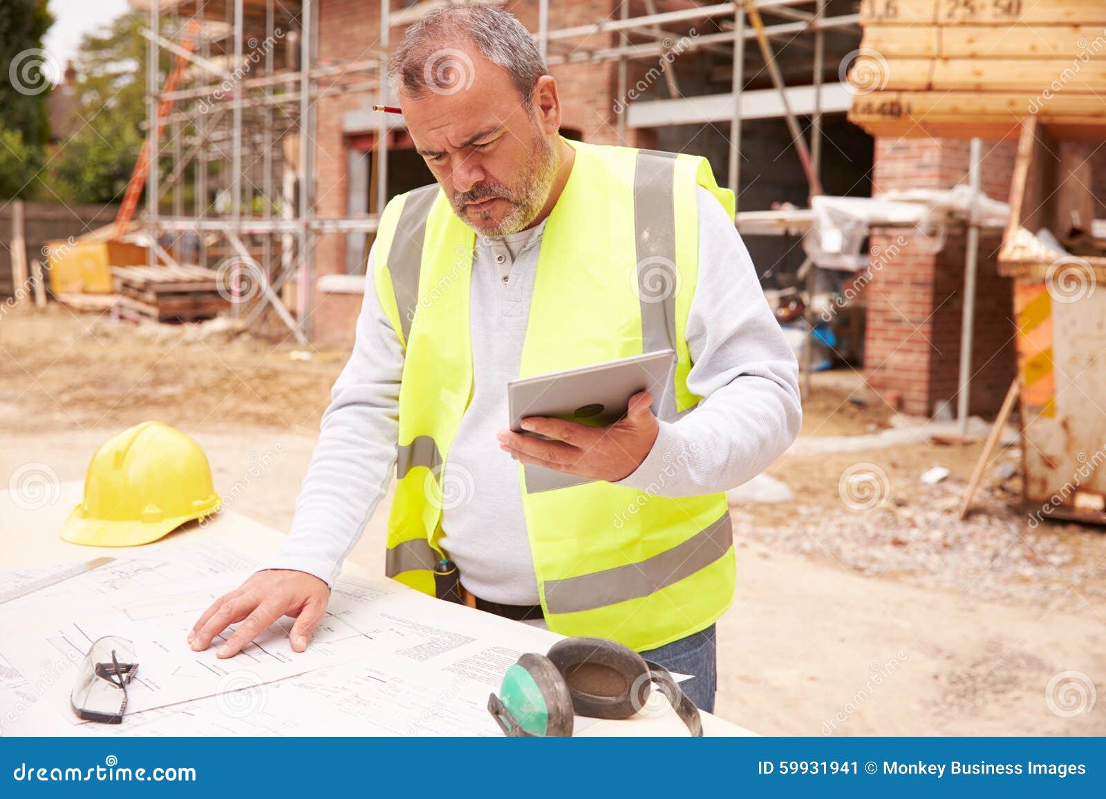 Construction Worker Using Digital Tablet on Building Site Stock Image ...