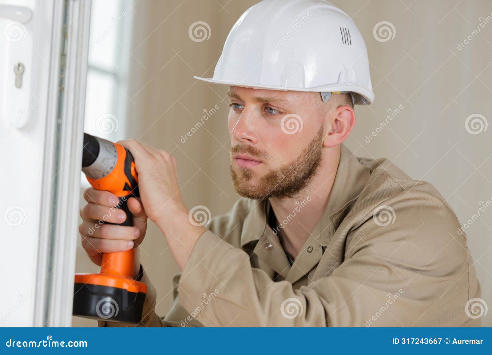 Construction Worker Using Drill To Install Replacement Window Stock ...