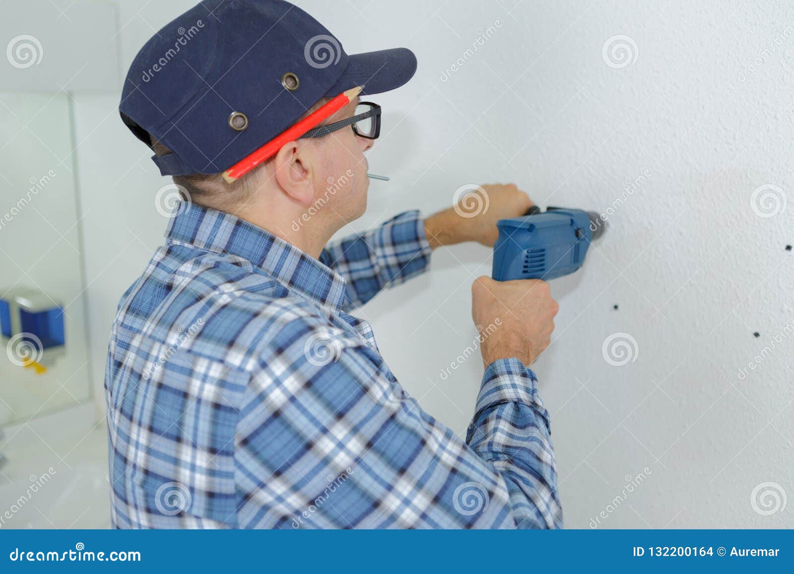 Construction Worker Using Electric Drill on Building Site Stock Photo ...