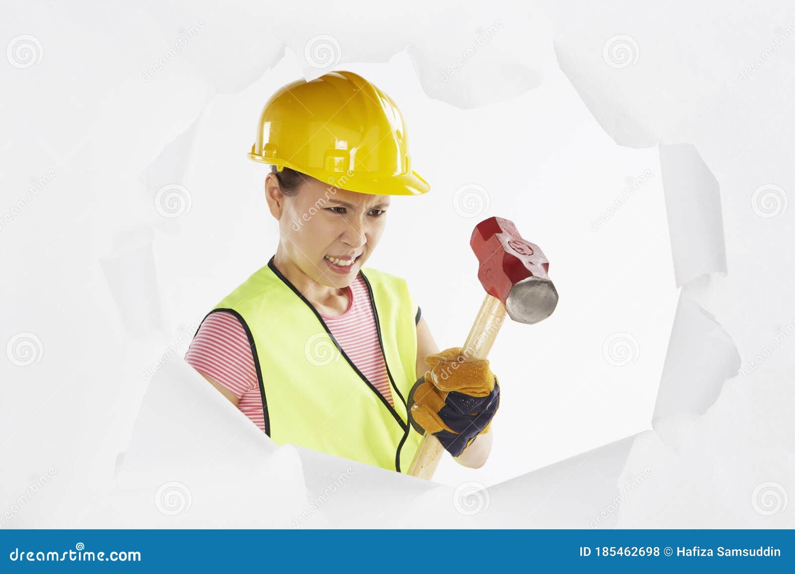 Construction Worker Using Hammer To Make a Hole in the Wall Stock Photo ...
