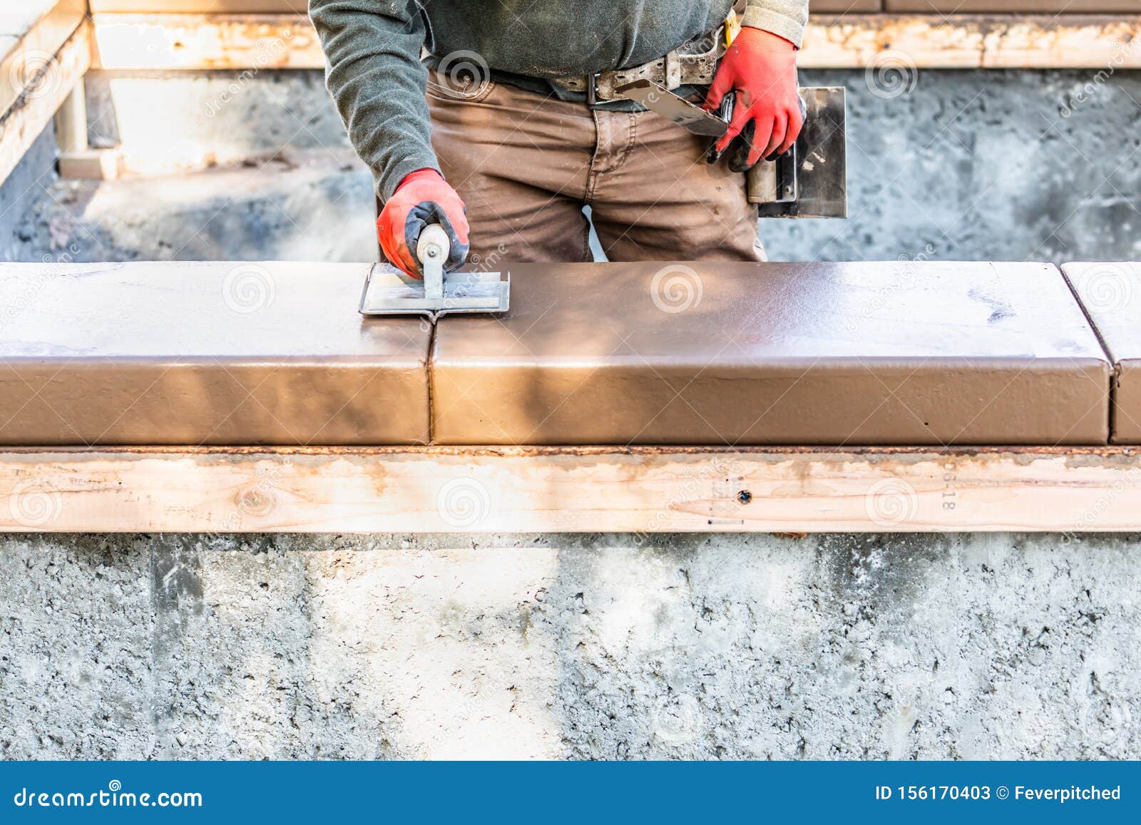 Construction Worker Using Hand Groover on Wet Cement Forming Coping ...