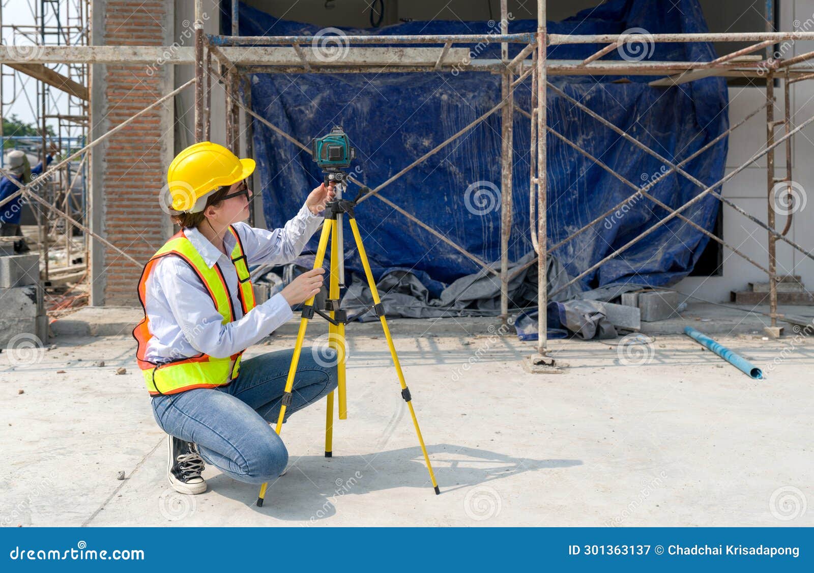 A Construction Worker is Using a Laser Gauge To Capture the Setting of ...