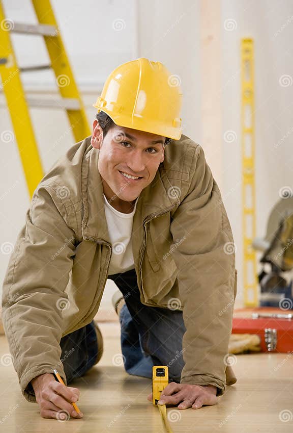 Construction Worker Using Measuring Tape Stock Photo - Image of ...